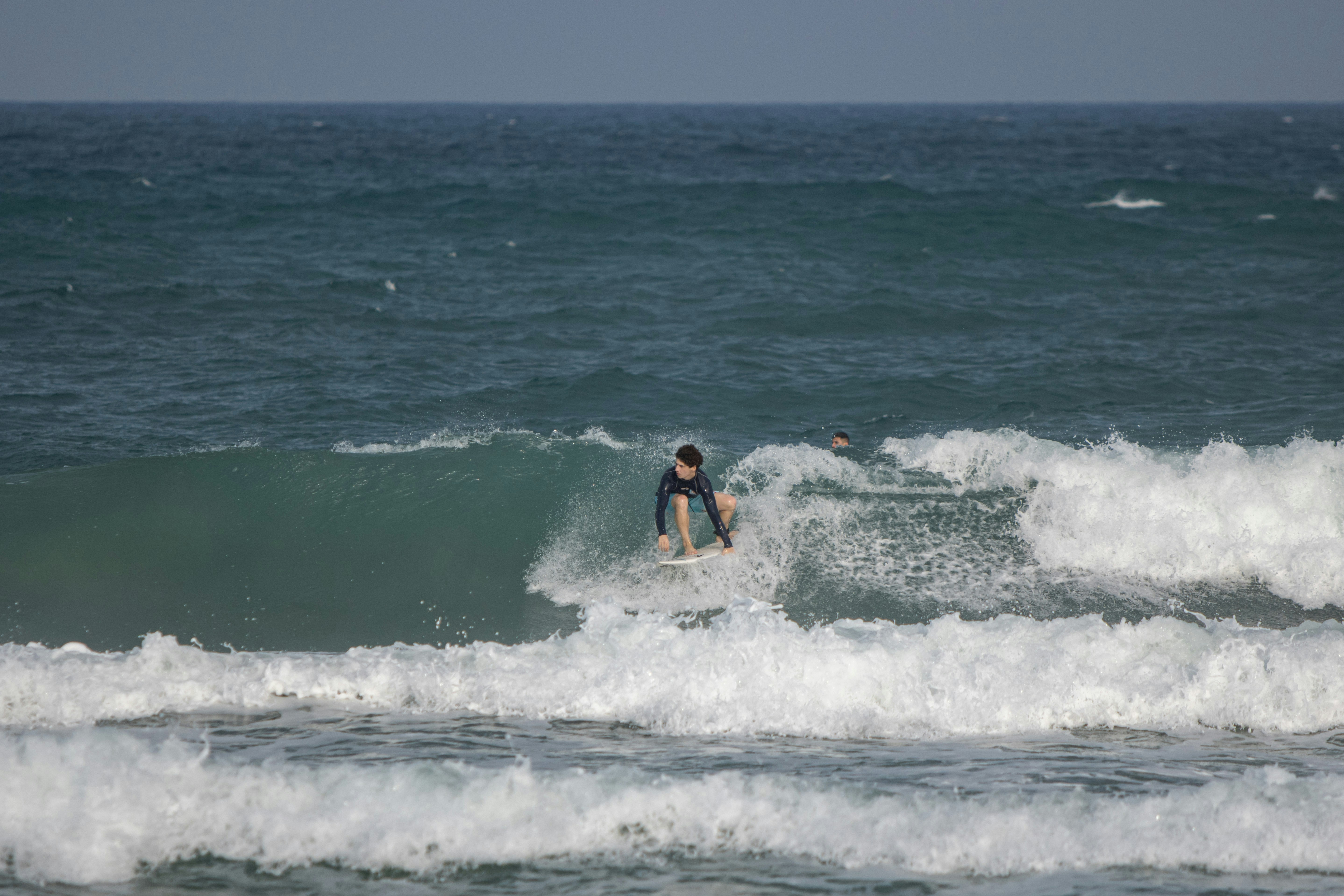 Green Crest Rider: A lone surfer carves through a curling green wave