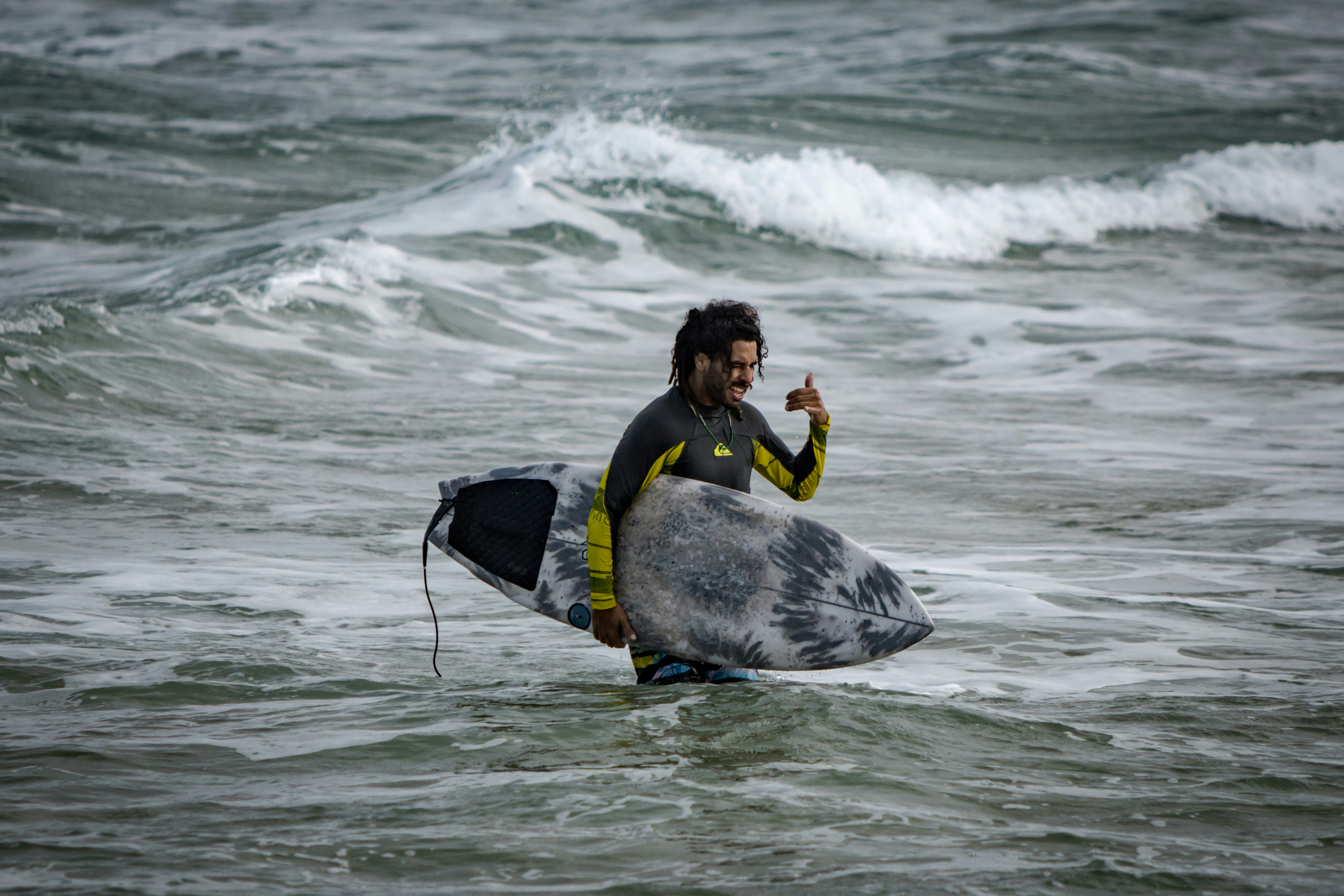 Gray Breaker: A Focused Surfer Commands a Marble-Patterned Board