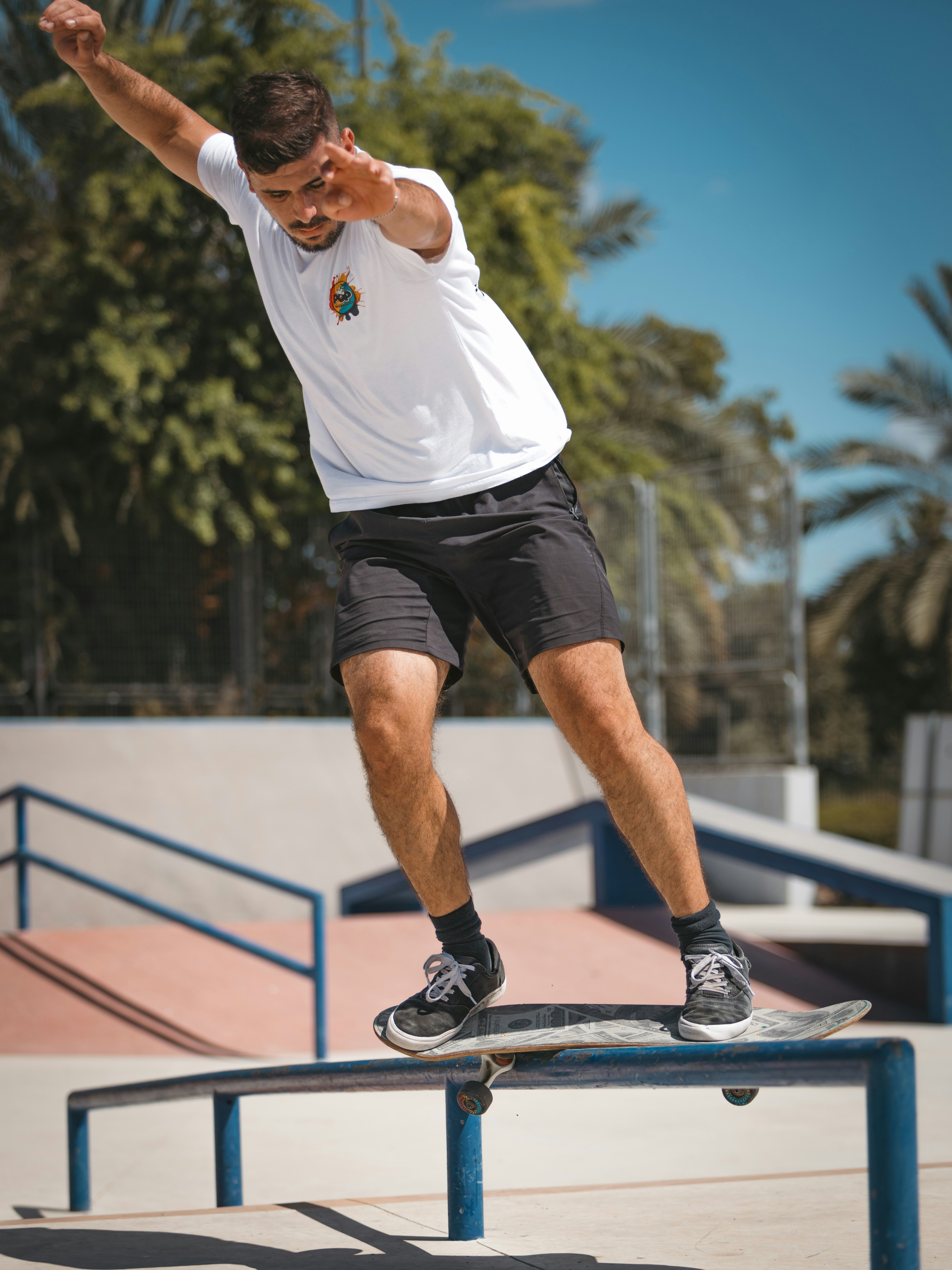 Sunlit Grind: Balance on a Blue Rail
