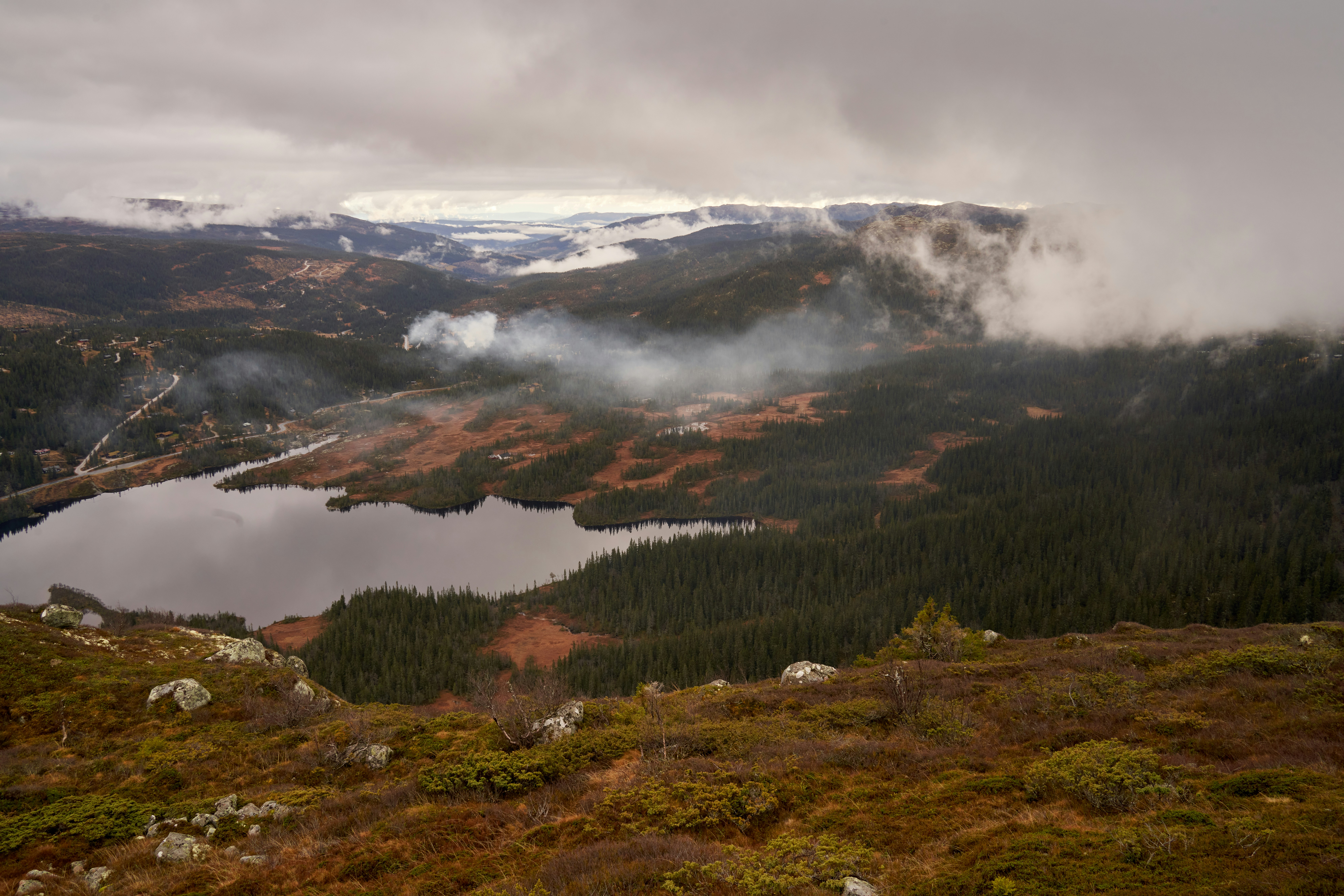 Cloud-veiled Highlands Embrace a Quiet Lake Basin