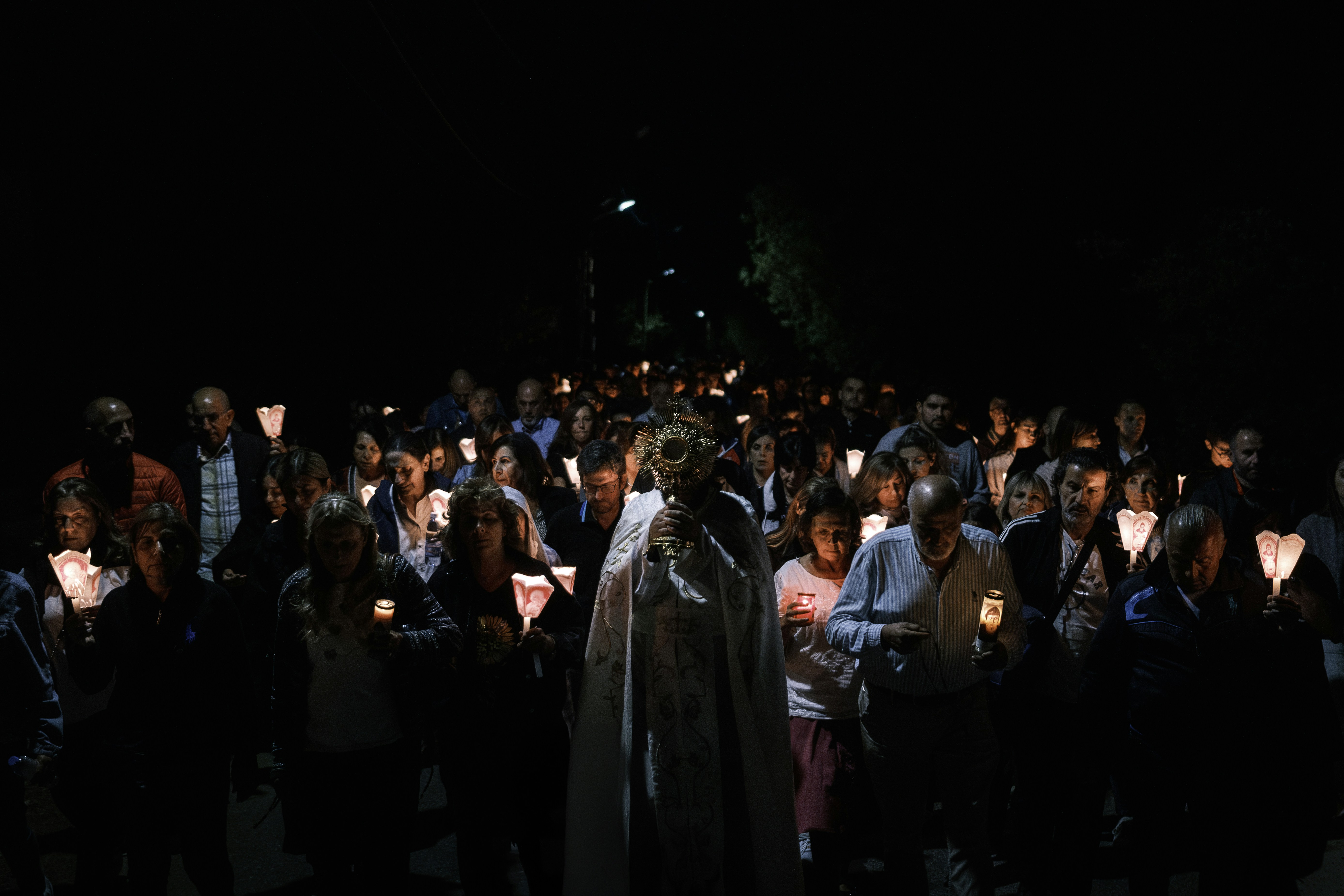 Midnight Procession: A Cleric Leads Through a Sea of Candlelight