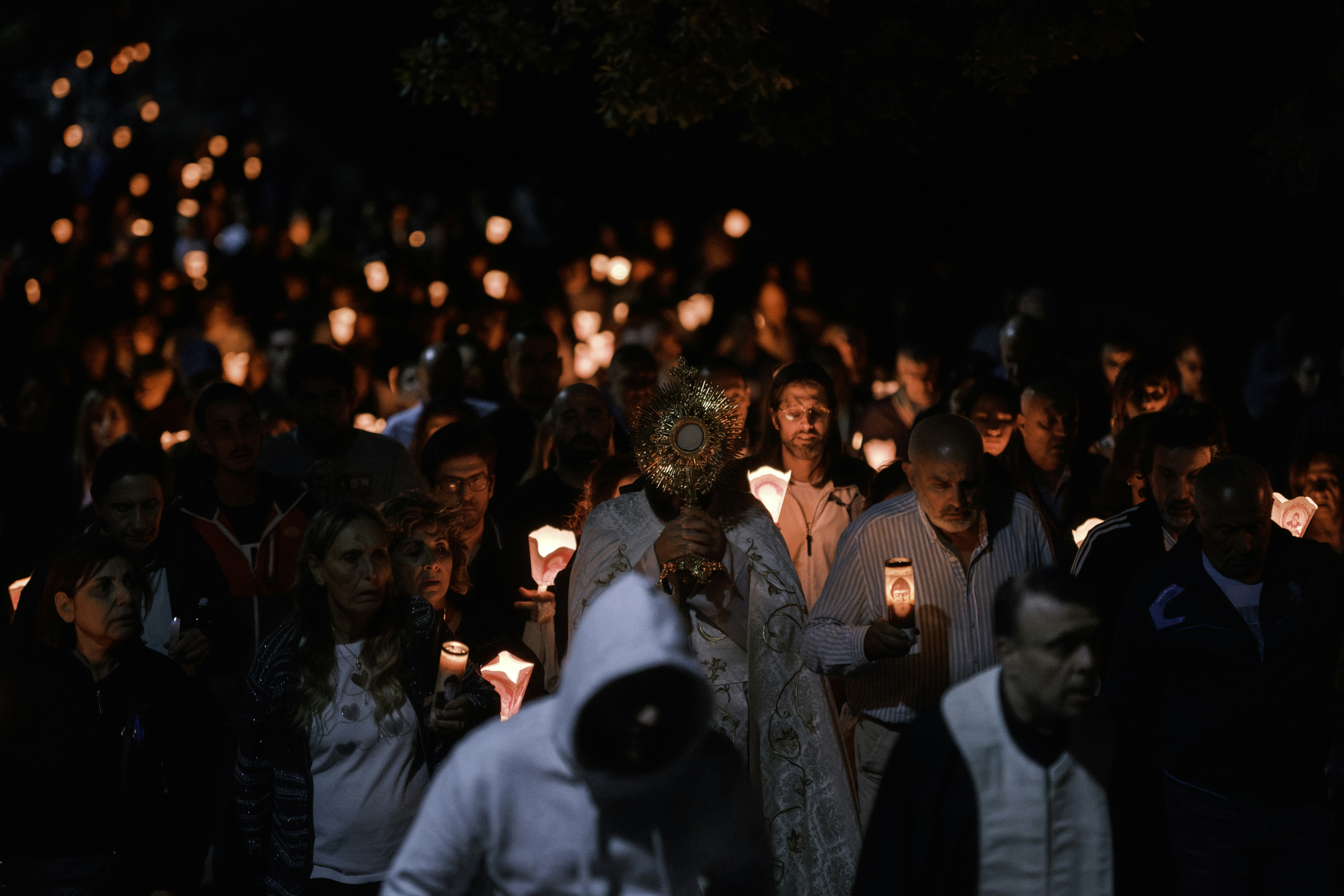 Monstrance of Light: A Candlelit Night Procession Through a Quiet Crowd