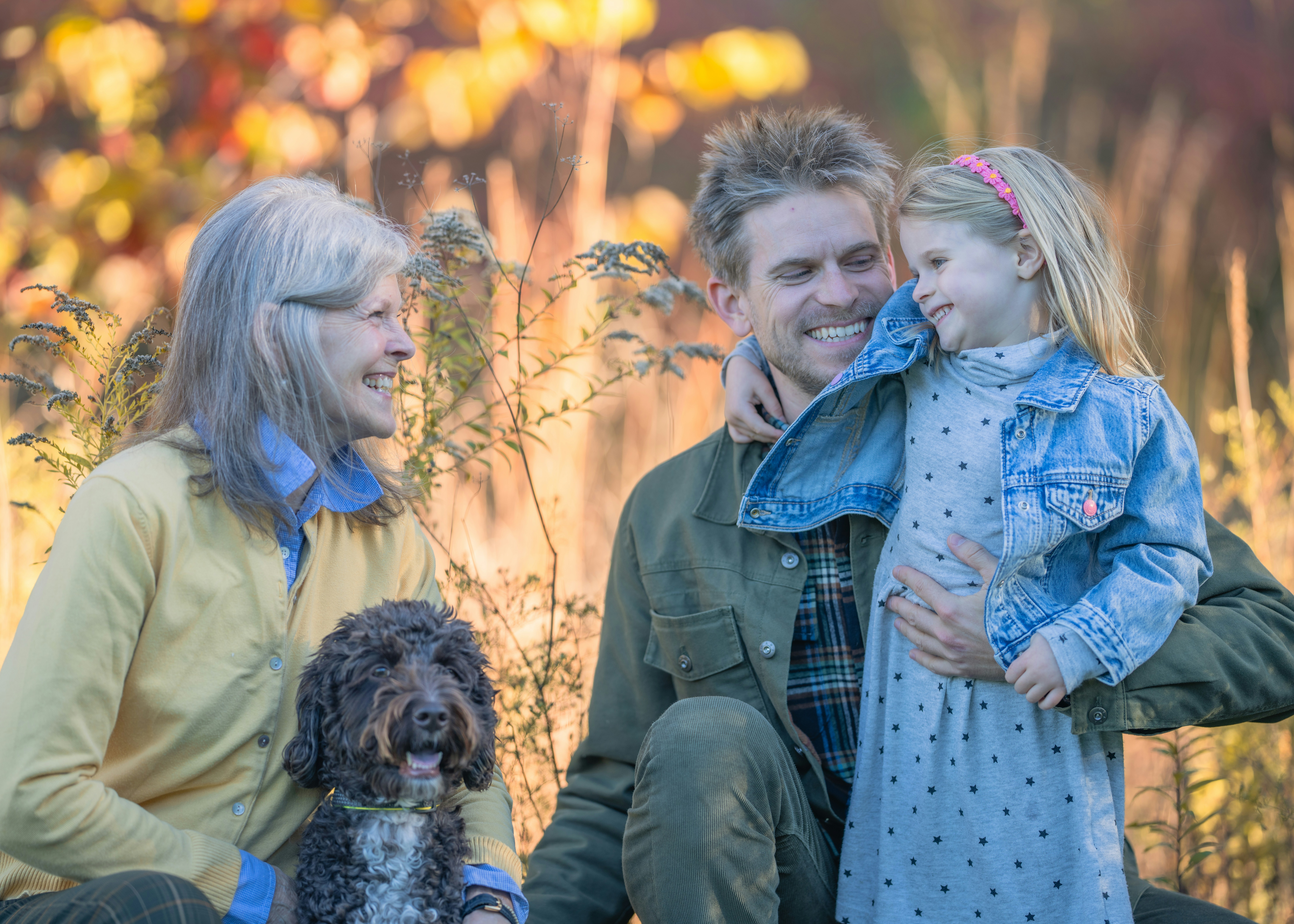 Autumn Glow Portrait: A Father, Daughter, and Grandmother Share a Tender Moment