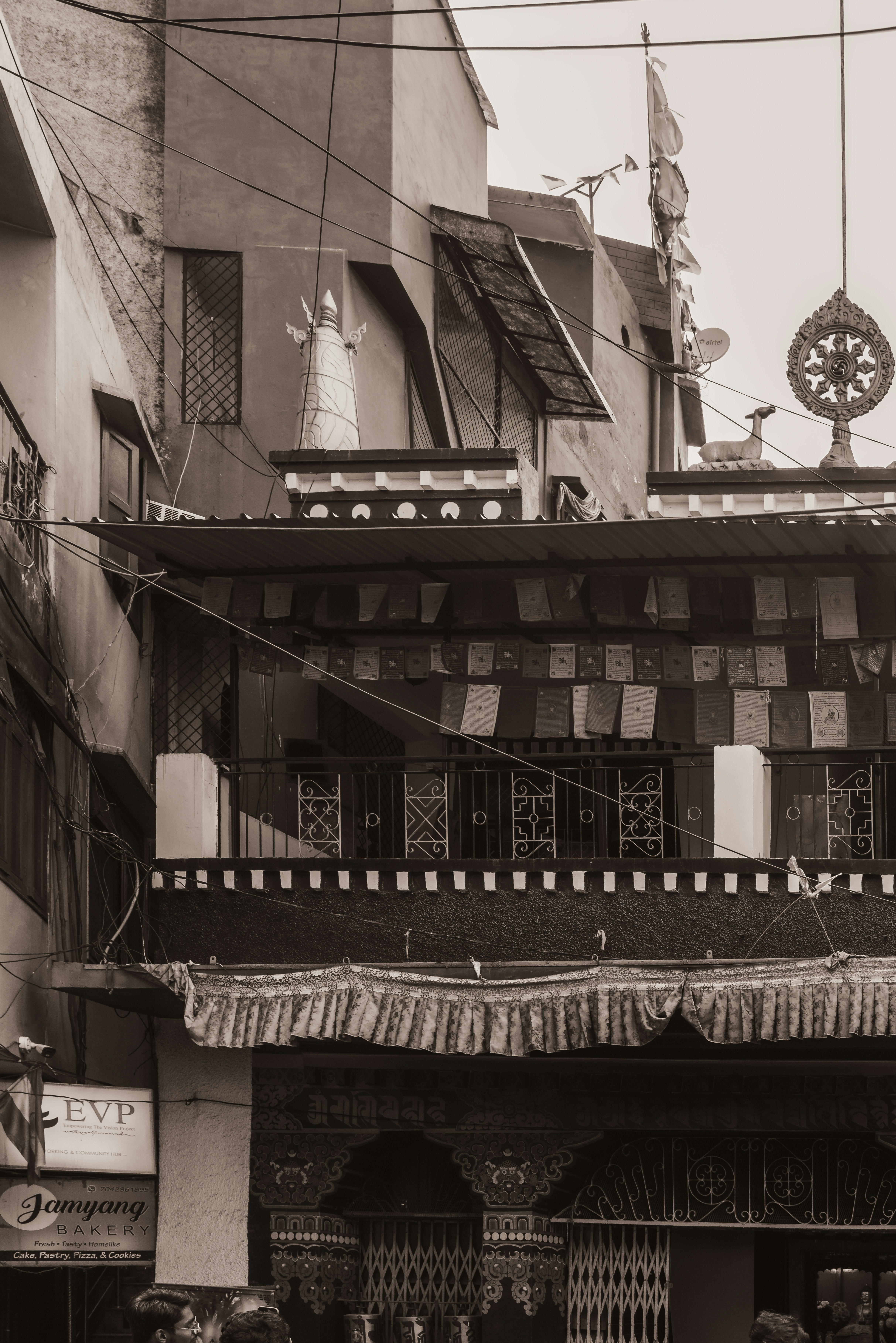 Majnu ka Tila, also known as “Little Tibet,” is a vibrant Tibetan colony in Delhi known for its monasteries, colorful facades, and distinct Himalayan architecture. Established in the 1960s by Tibetan refugees, the neighborhood has become a cultural landmark blending spirituality, community, and commerce. Its temples and prayer flags reflect Tibetan Buddhist heritage, while the intricate designs and motifs—like those seen on this building—represent traditional artistry preserved through generations.