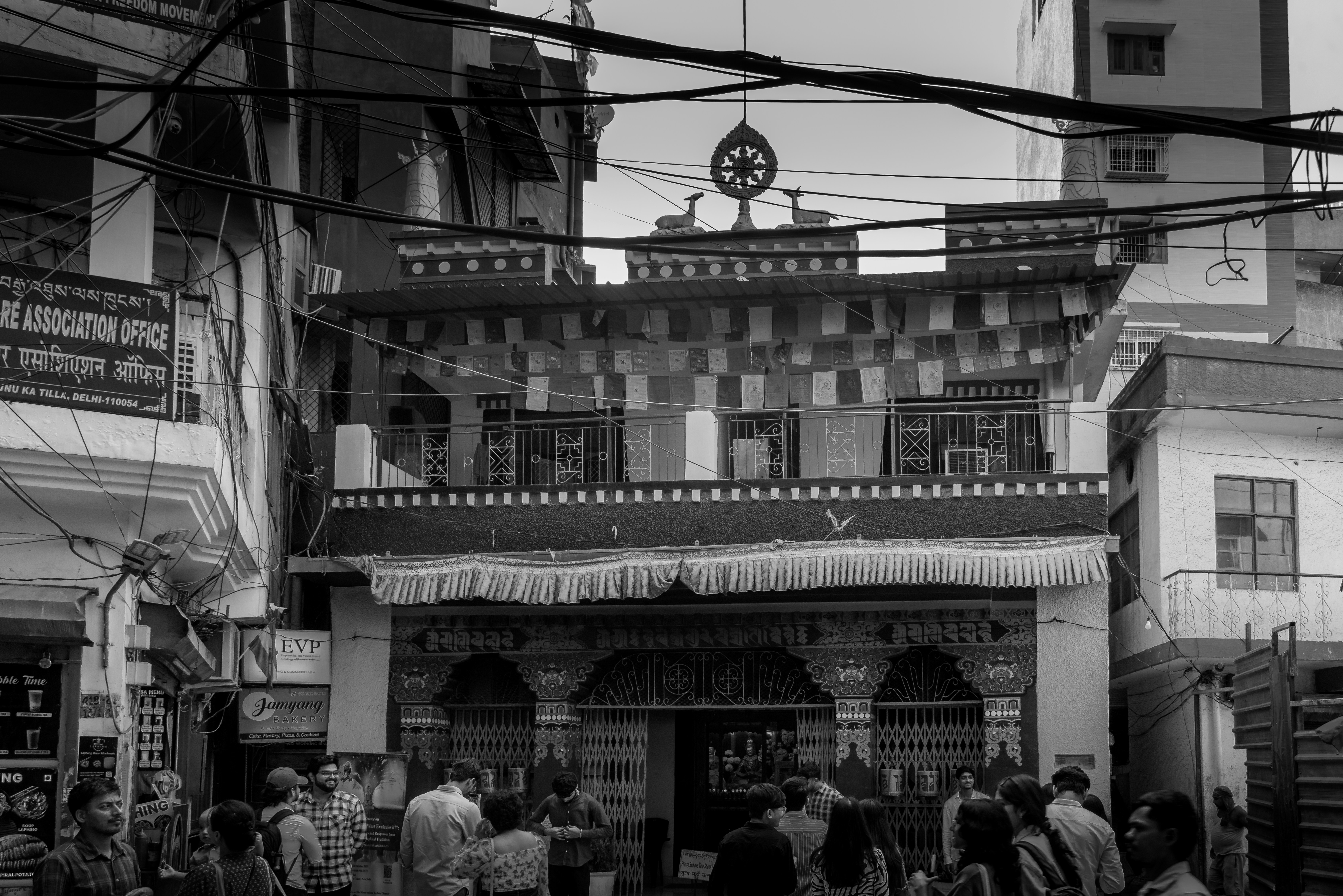 Majnu ka Tila, also known as “Little Tibet,” is a vibrant Tibetan colony in Delhi known for its monasteries, colorful facades, and distinct Himalayan architecture. Established in the 1960s by Tibetan refugees, the neighborhood has become a cultural landmark blending spirituality, community, and commerce. Its temples and prayer flags reflect Tibetan Buddhist heritage, while the intricate designs and motifs—like those seen on this building—represent traditional artistry preserved through generations.