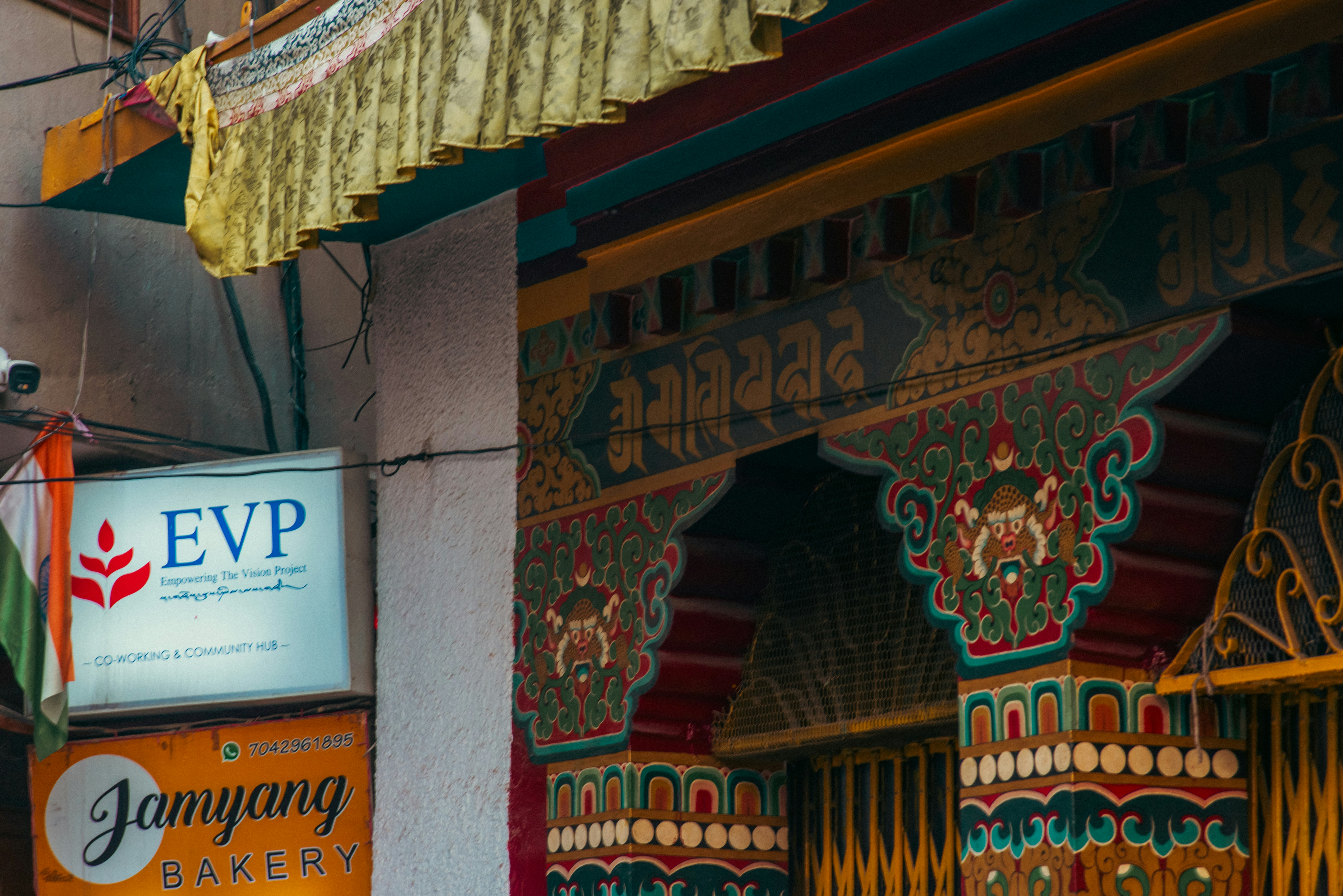 EVP and Jamyang Bakery Signage Framed by a Tibetan-inspired Carved Façade