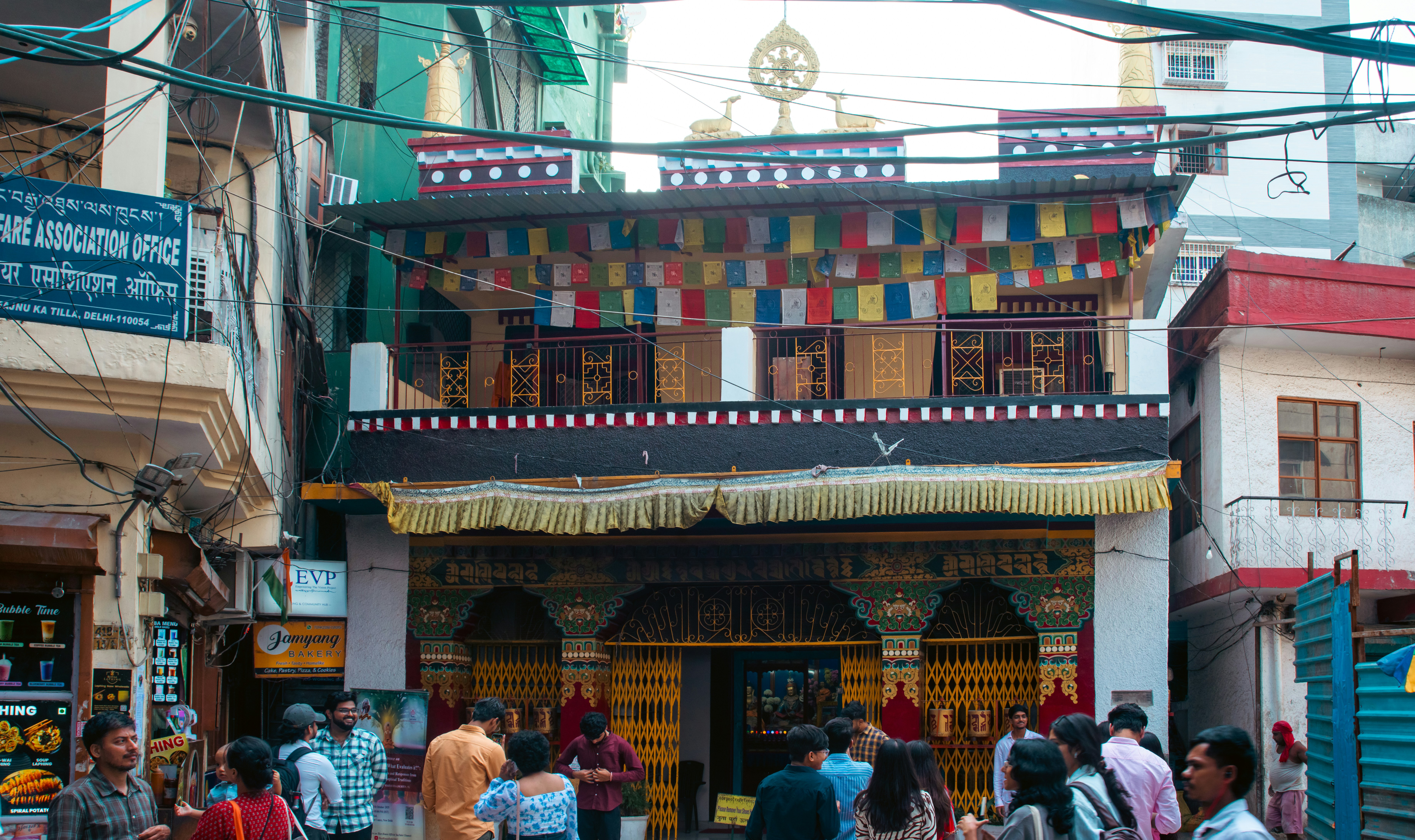 Majnu ka Tila, also known as “Little Tibet,” is a vibrant Tibetan colony in Delhi known for its monasteries, colorful facades, and distinct Himalayan architecture. Established in the 1960s by Tibetan refugees, the neighborhood has become a cultural landmark blending spirituality, community, and commerce. Its temples and prayer flags reflect Tibetan Buddhist heritage, while the intricate designs and motifs—like those seen on this building—represent traditional artistry preserved through generations.