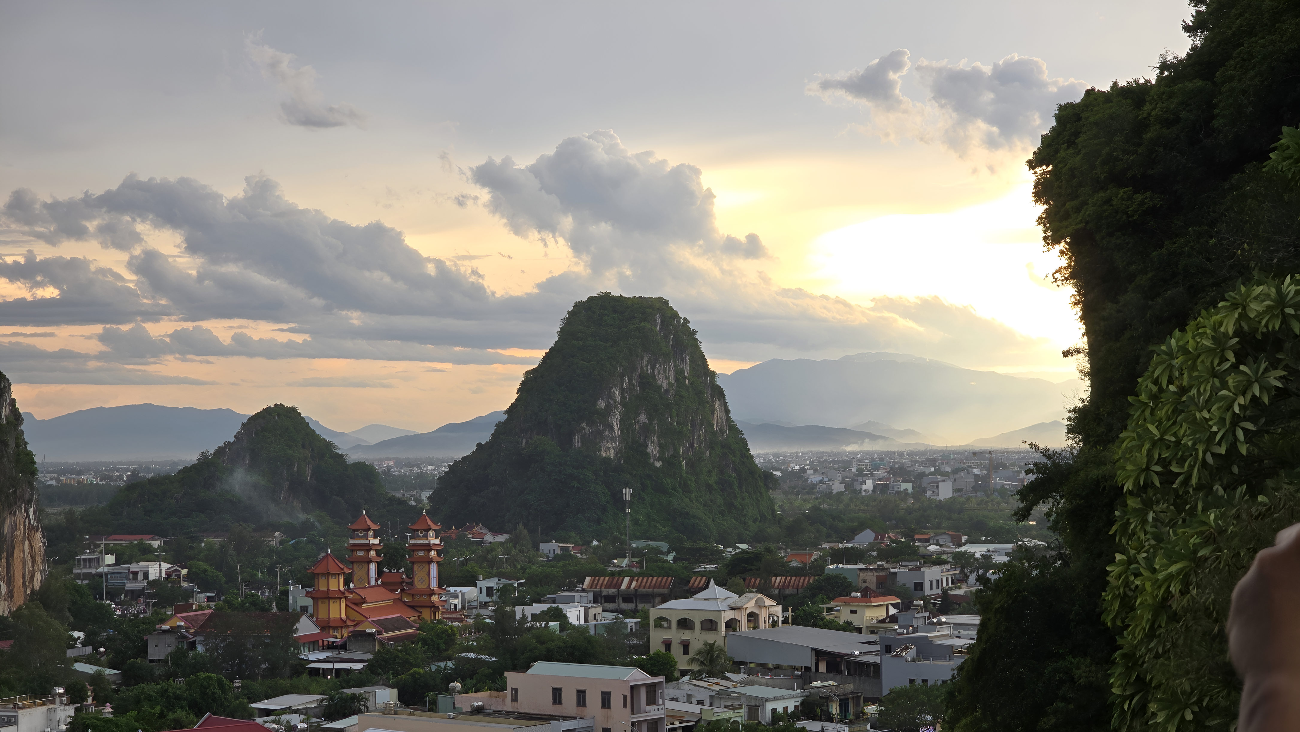 Sunset over a town with mountains and clouds photo – Free Sunset Image ...