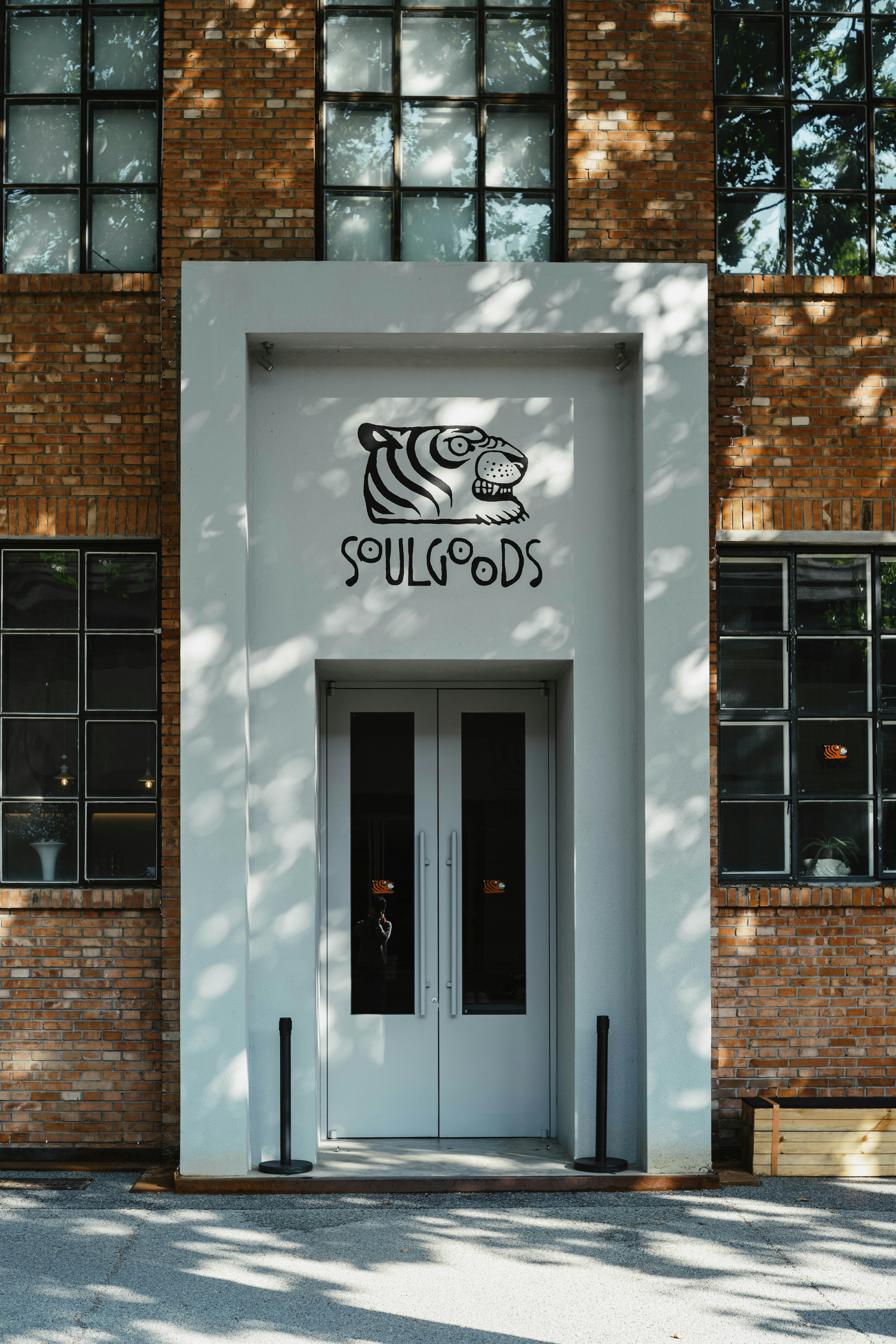 Entrance of a brick building with a tiger logo. photo – Free Business ...