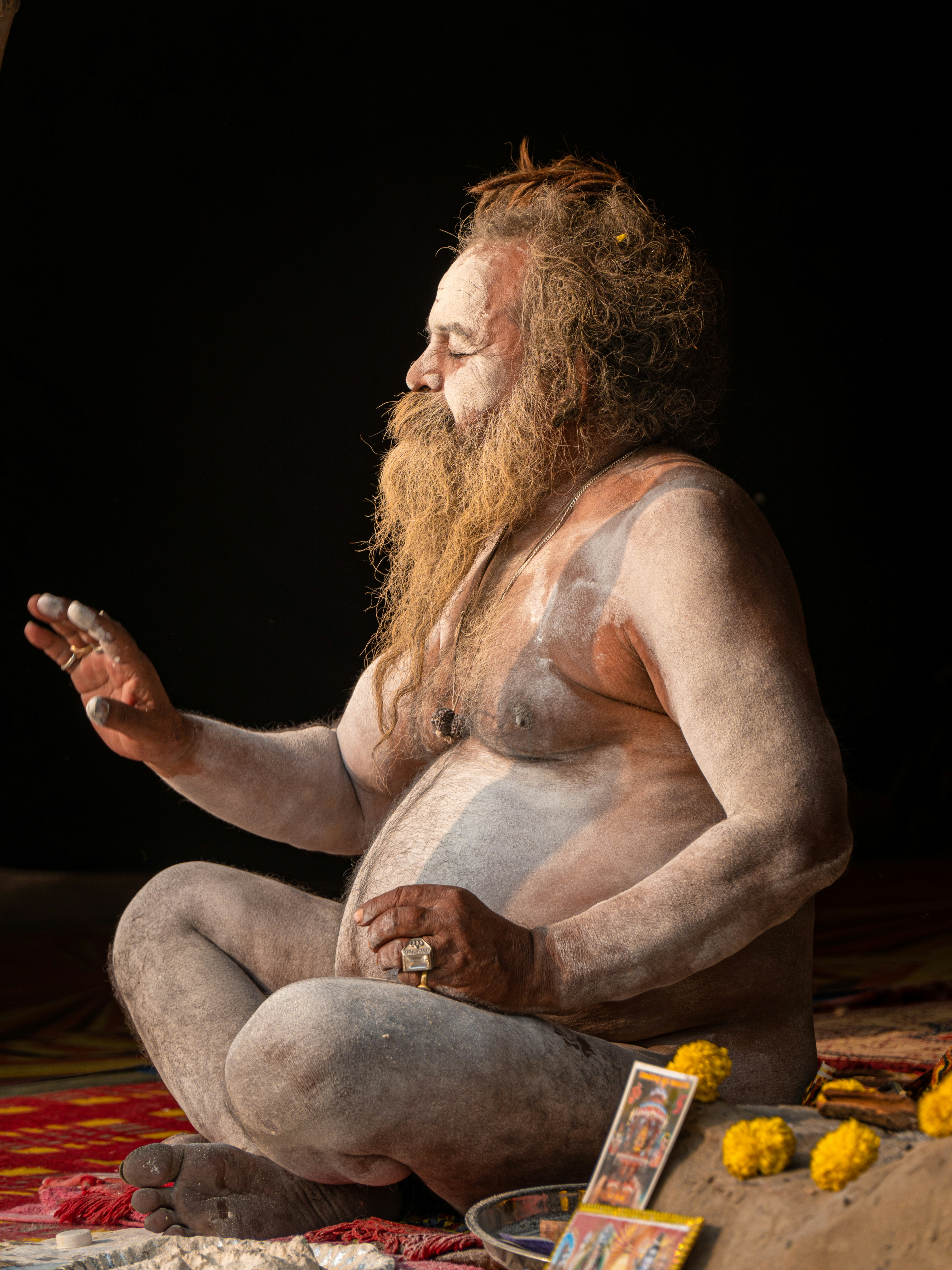 Serene Sadhu in Meditation: Embered Portrait on a Dark Stage