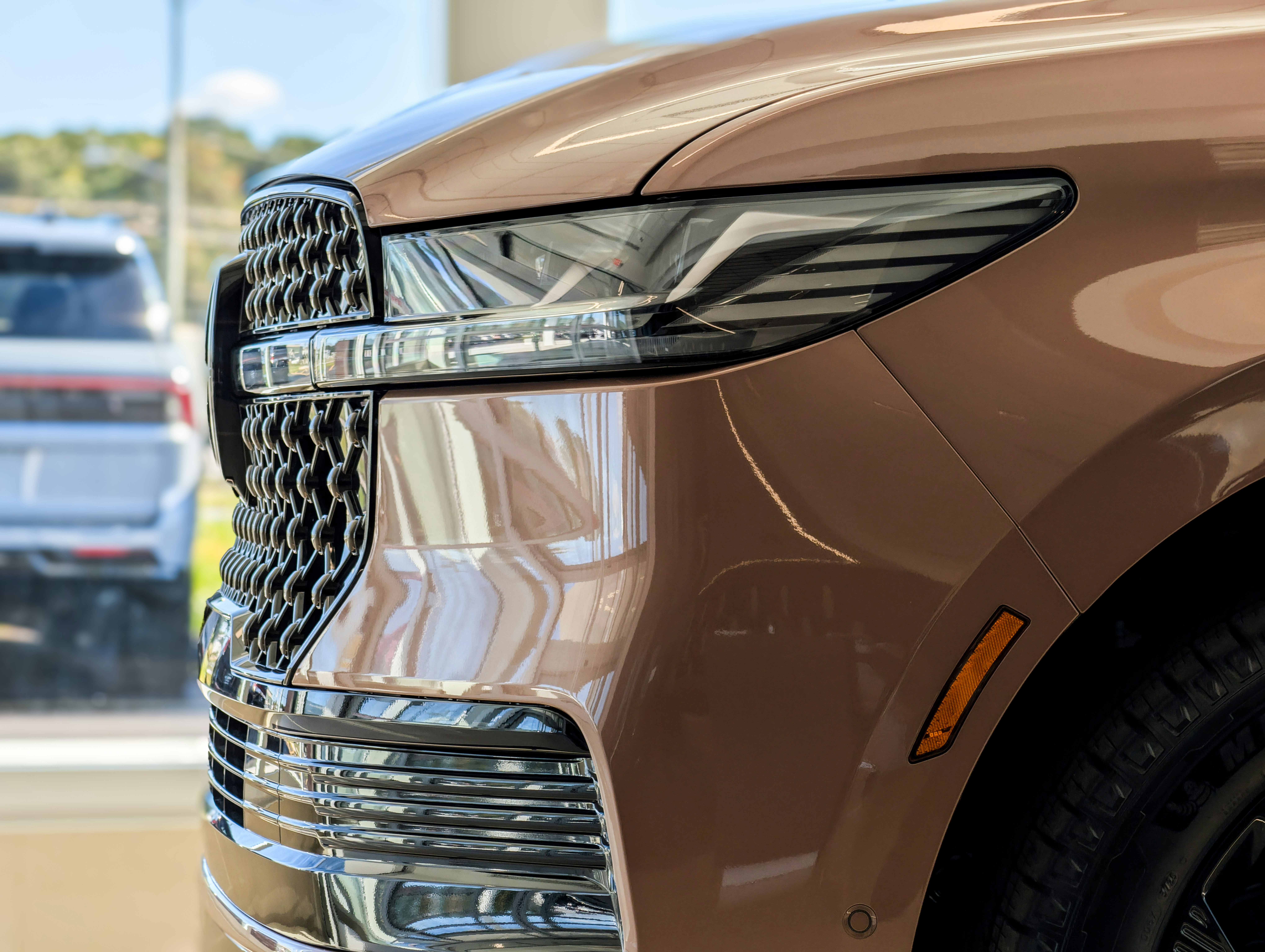 The striking, intricate chrome grille and sleek, split LED lighting form a powerful and distinctive front-end presence. This opulent copper finish highlights the meticulous, high-end craftsmanship in an undeniably commanding aesthetic statement.