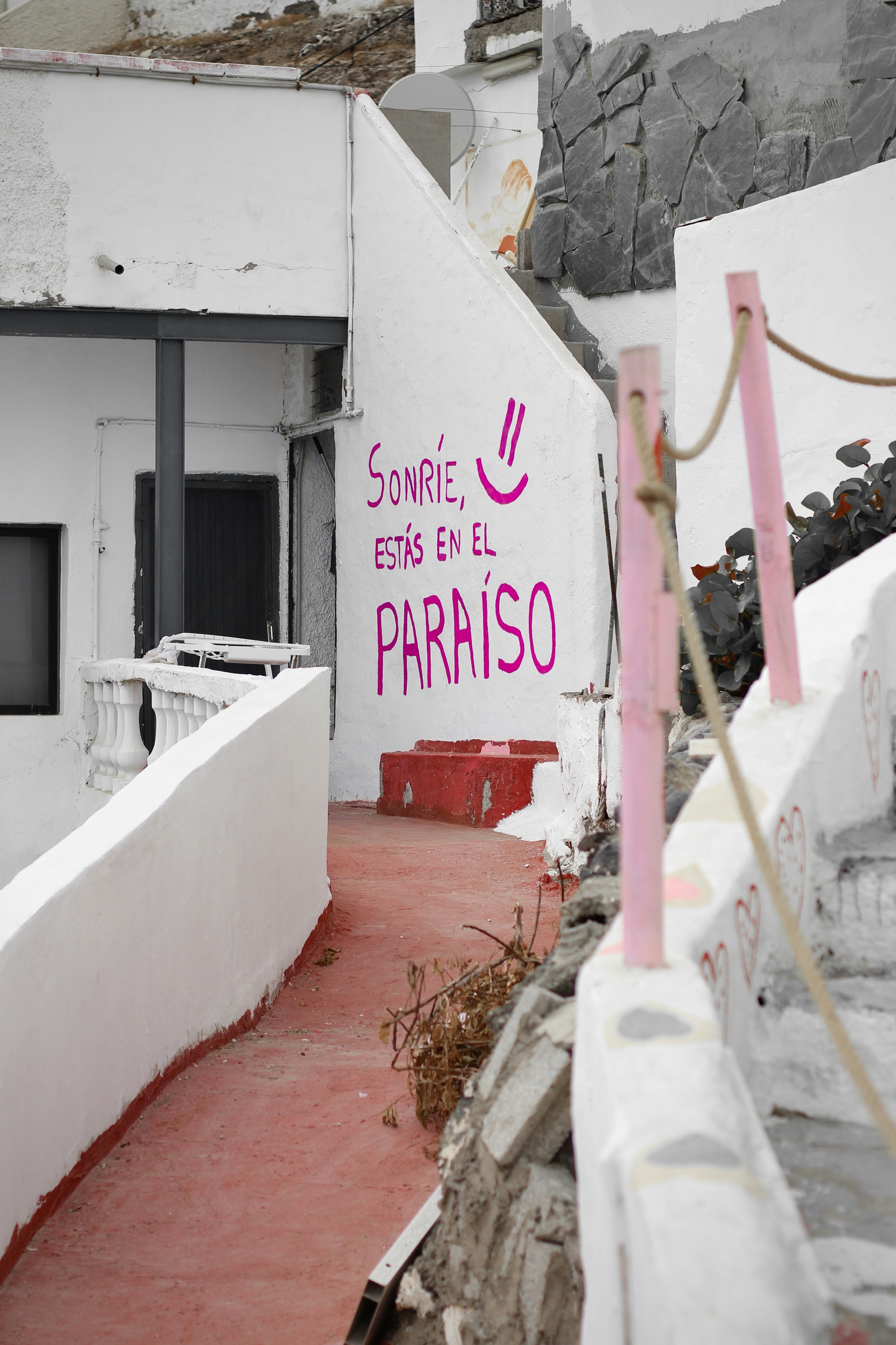 Paradise Graffiti: Pink Confession on a Whitewashed Staircase
