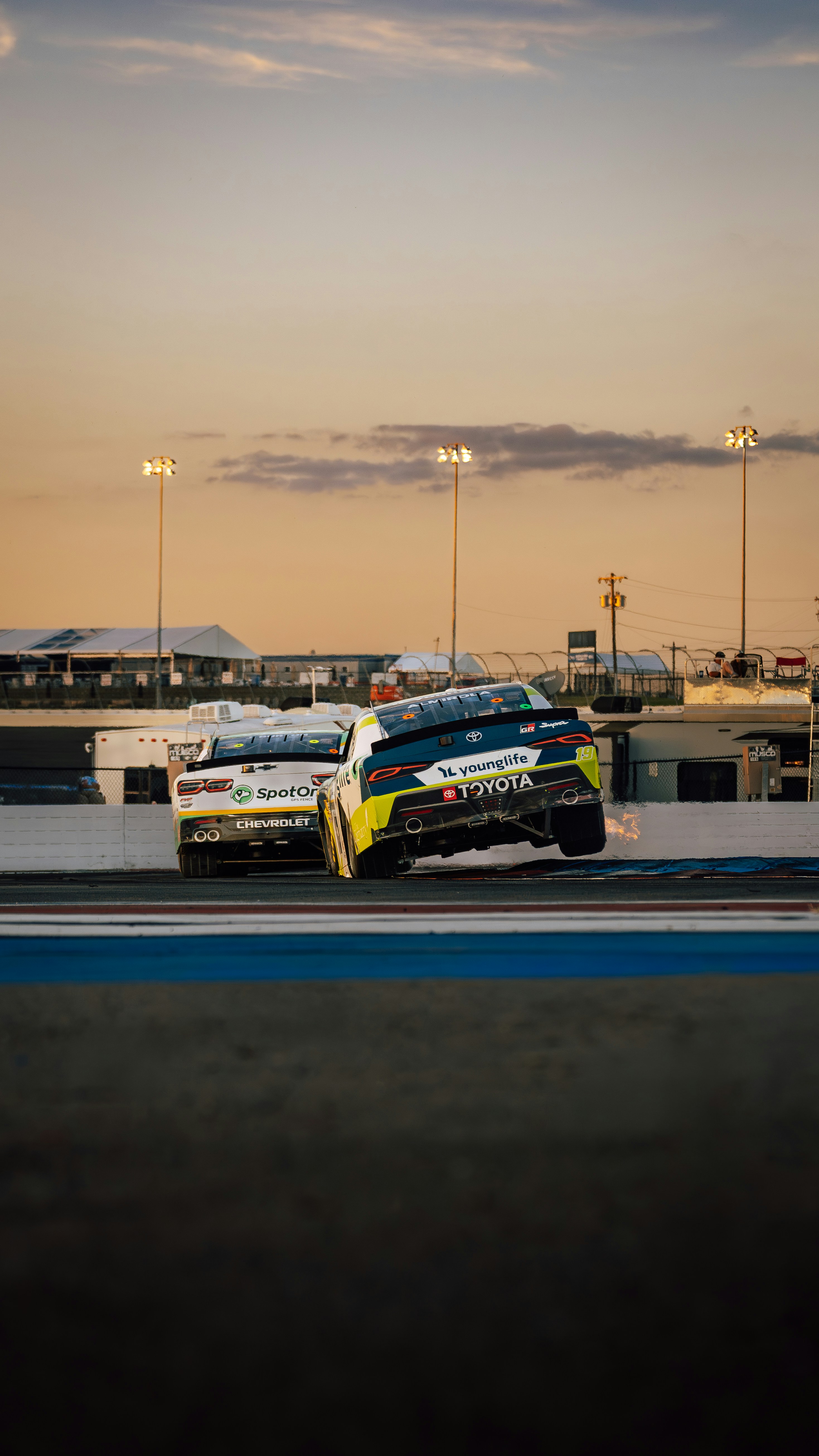 Sunset Leap: Blue Toyota Transits a Jump on the Turn