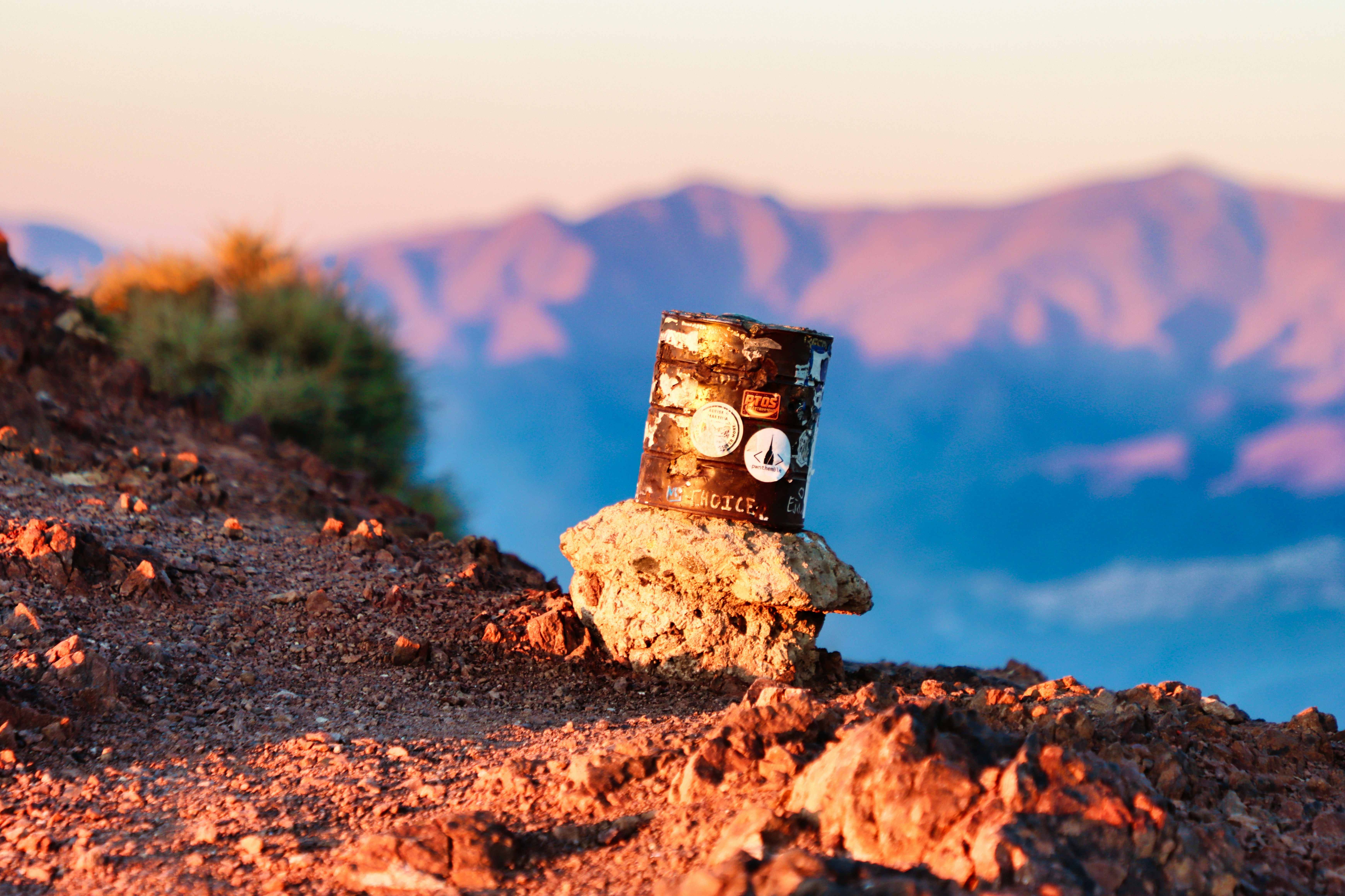 Alpine Ember: A Weathered Barrel Basking in Alpine Sunset