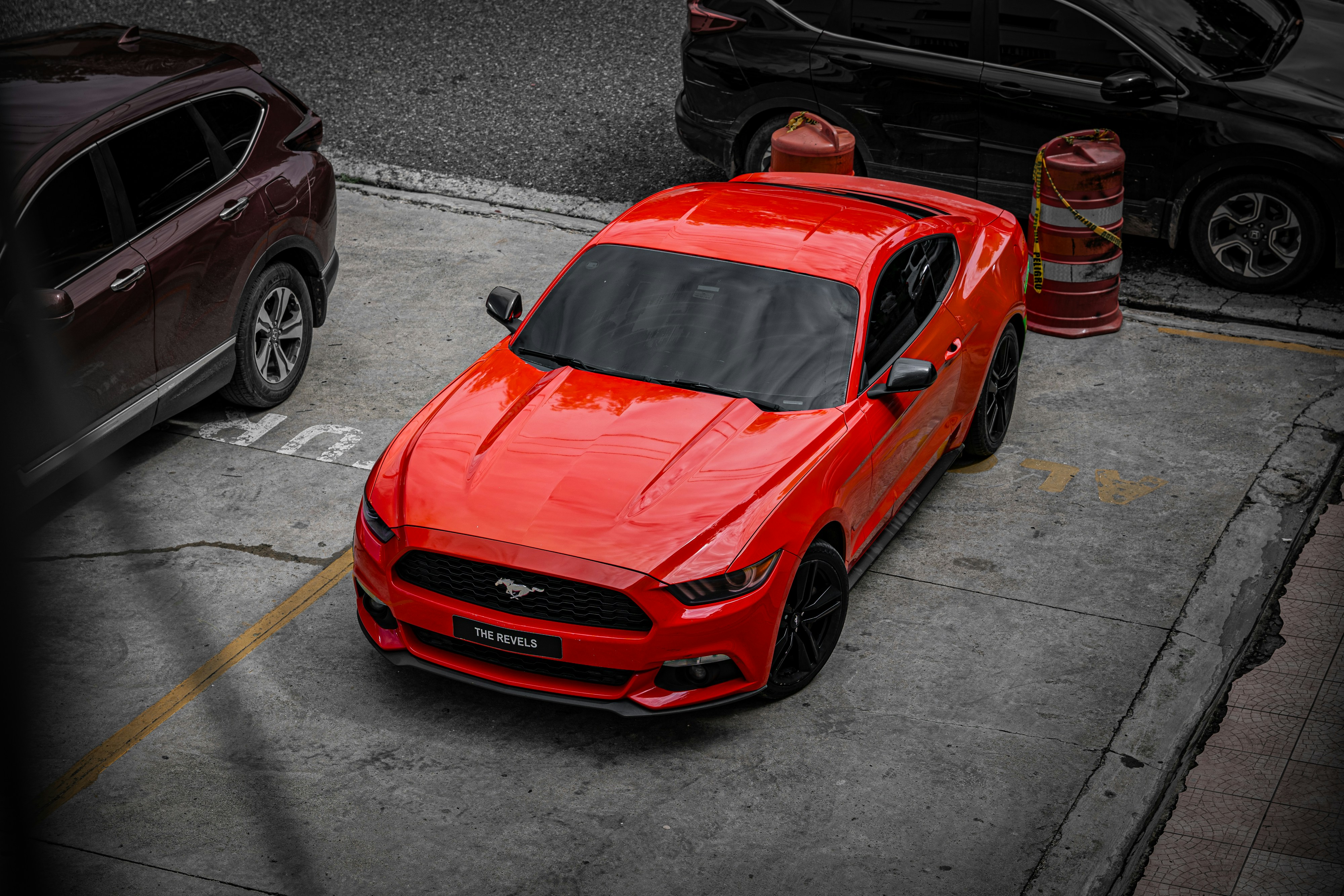 Scarlet Mustang Anchored in an Urban Parking Moment