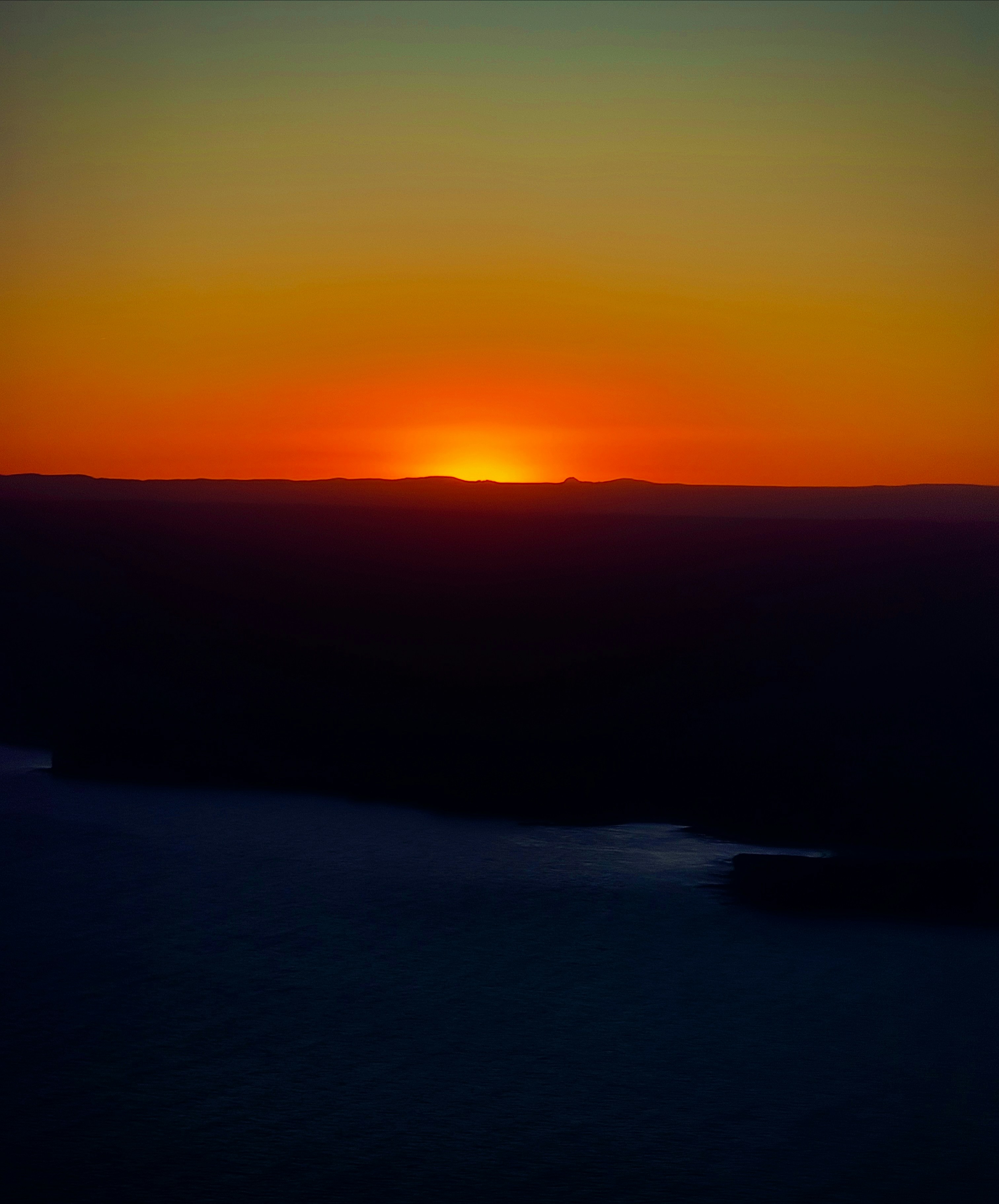 Horizon Ember: A Quiet Sunset Over Darkened Waters