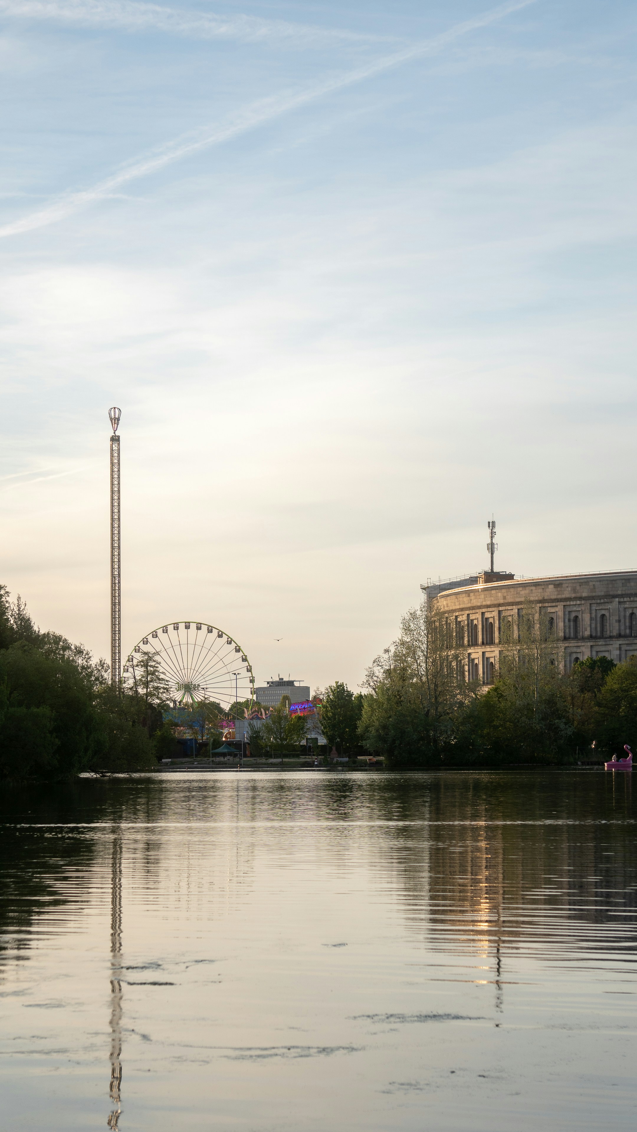 Dusk on the Quiet River: Ferris Wheel Framed by Historic Riverside Architecture