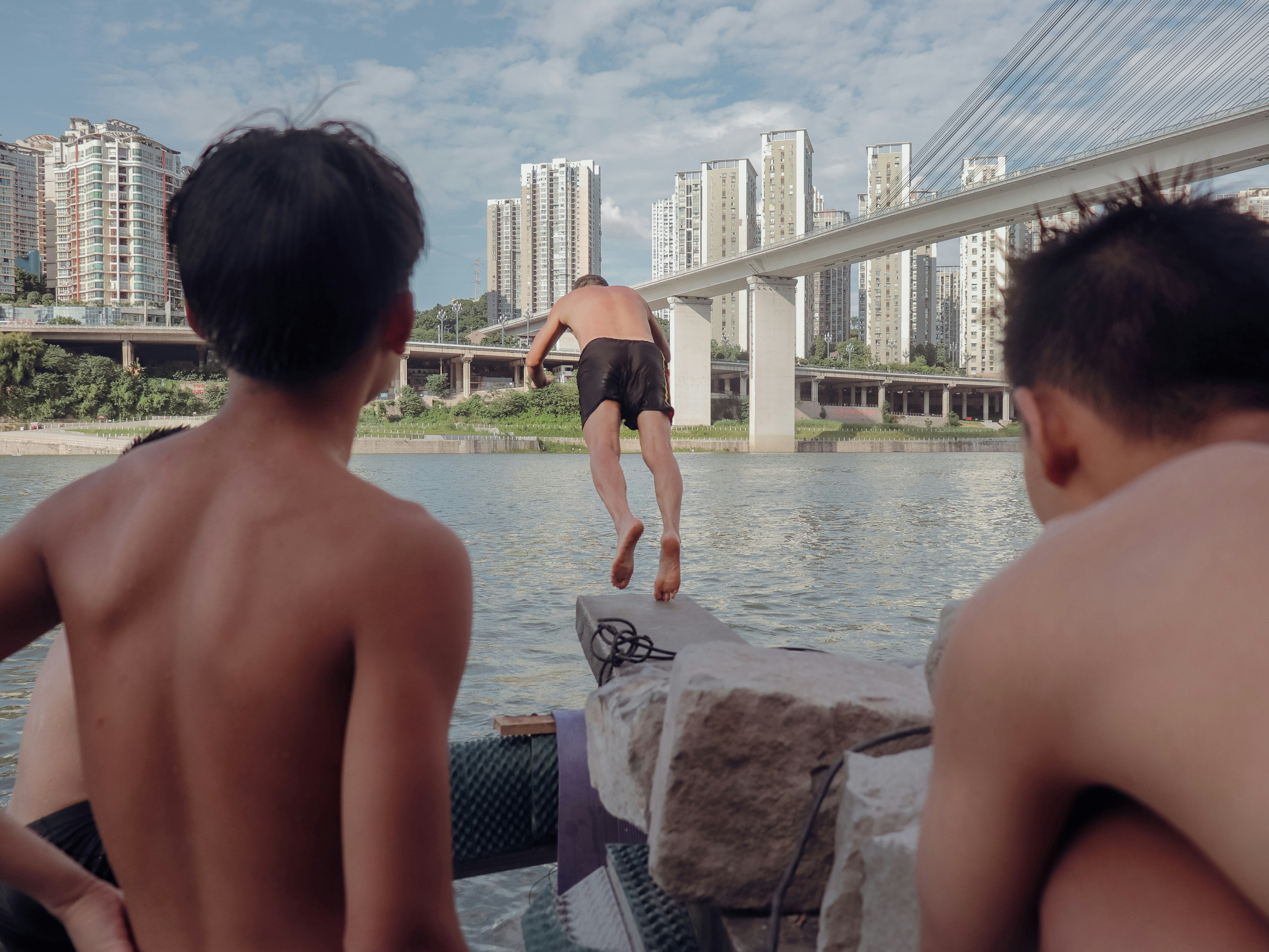 Midair Leap Over the Riverfront: Concrete, Water, and Skyline