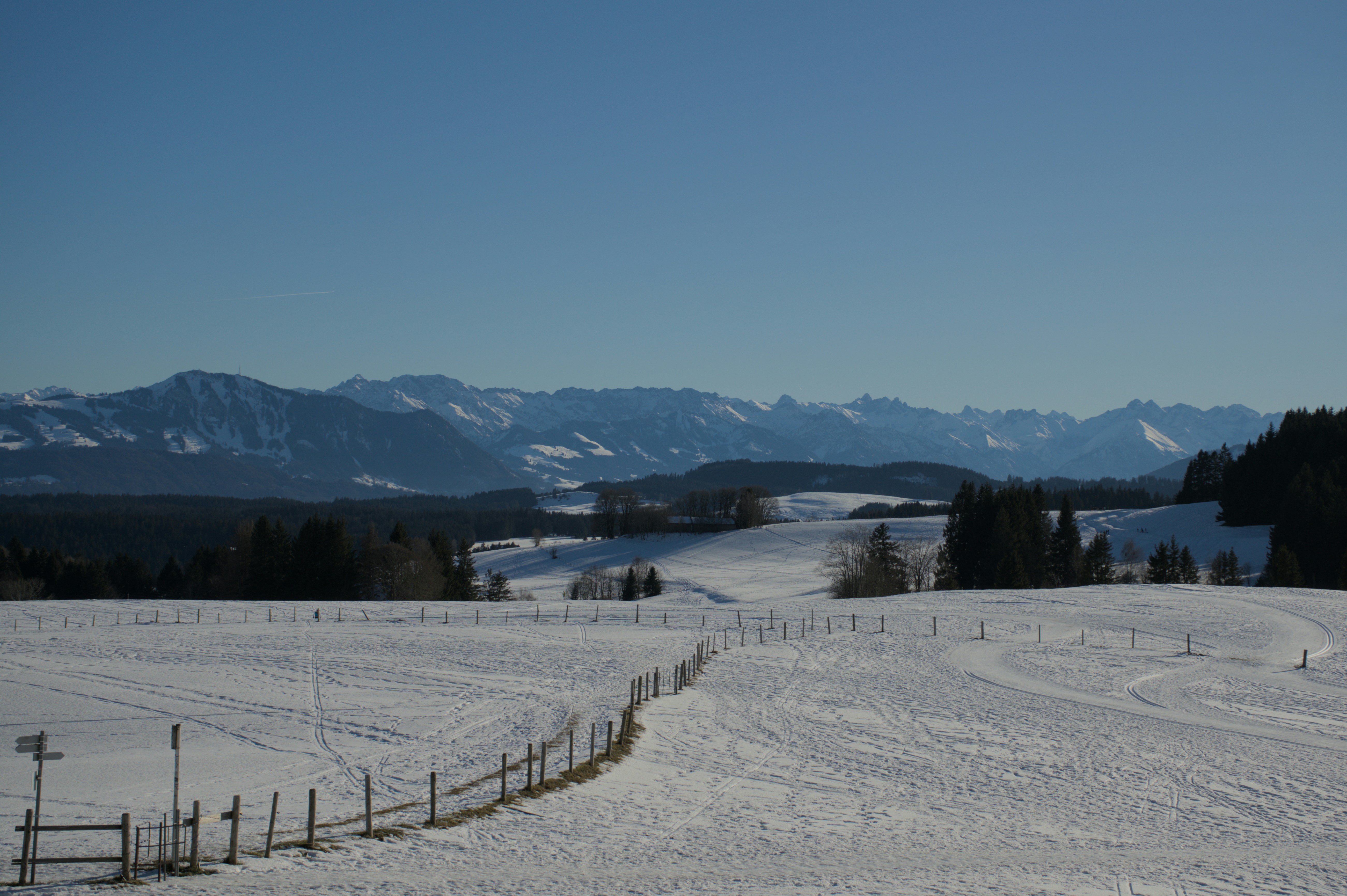 Snowy field with fence and distant mountains photo – Free Winter Image ...