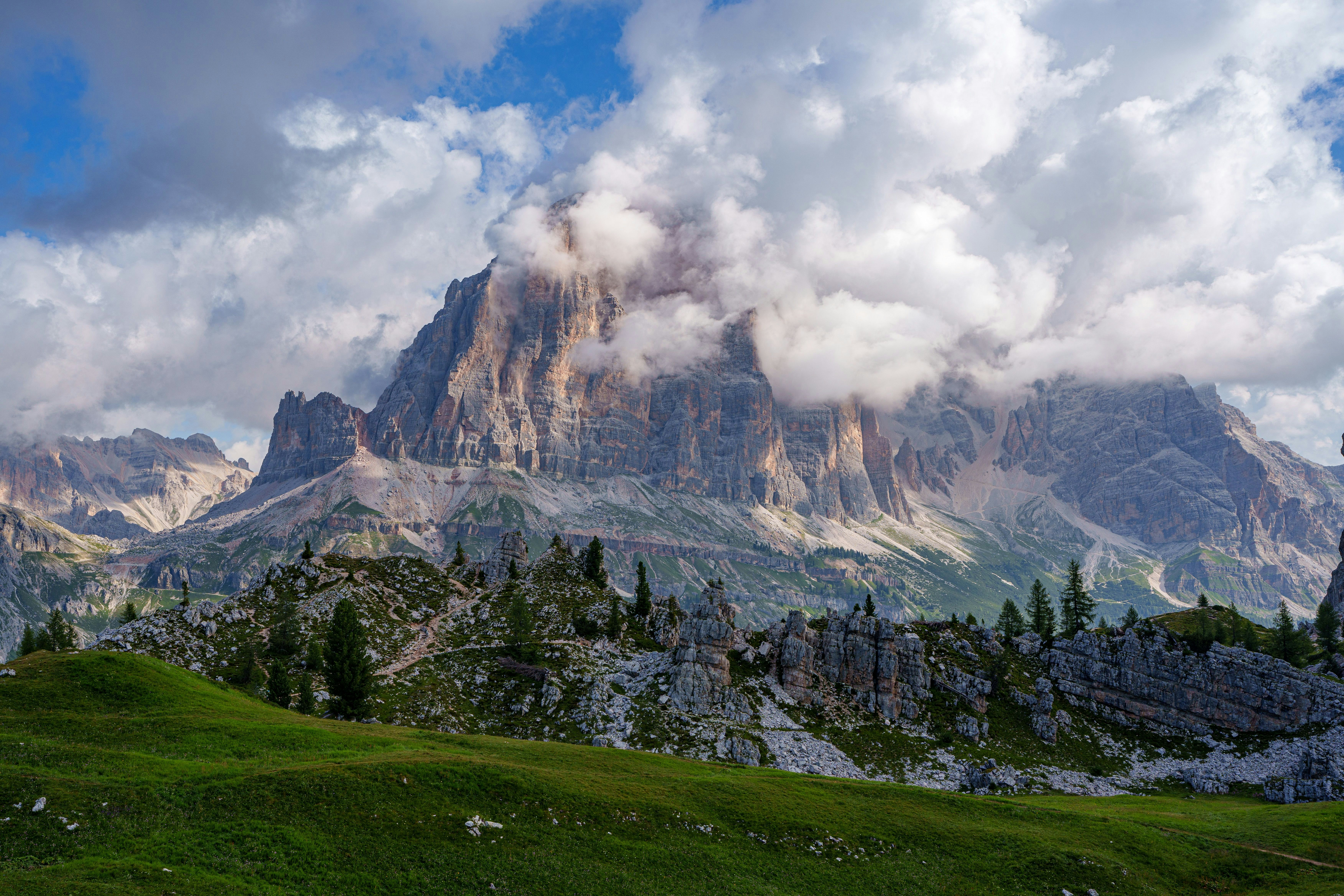 Jagged mountain peaks shrouded in dramatic clouds photo – Free Travel ...