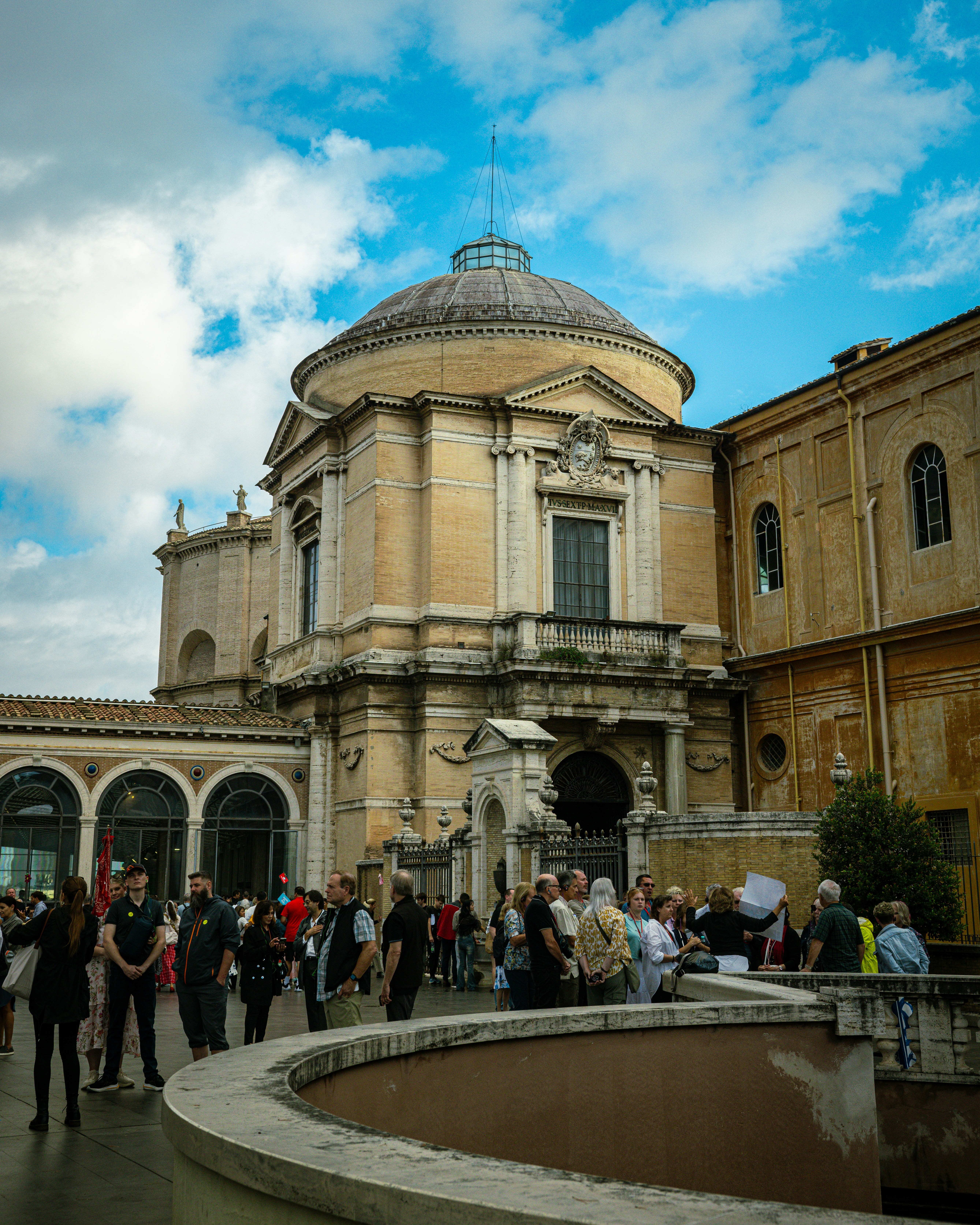Sunlit Domed Facade Over a Bustling Italian Plaza