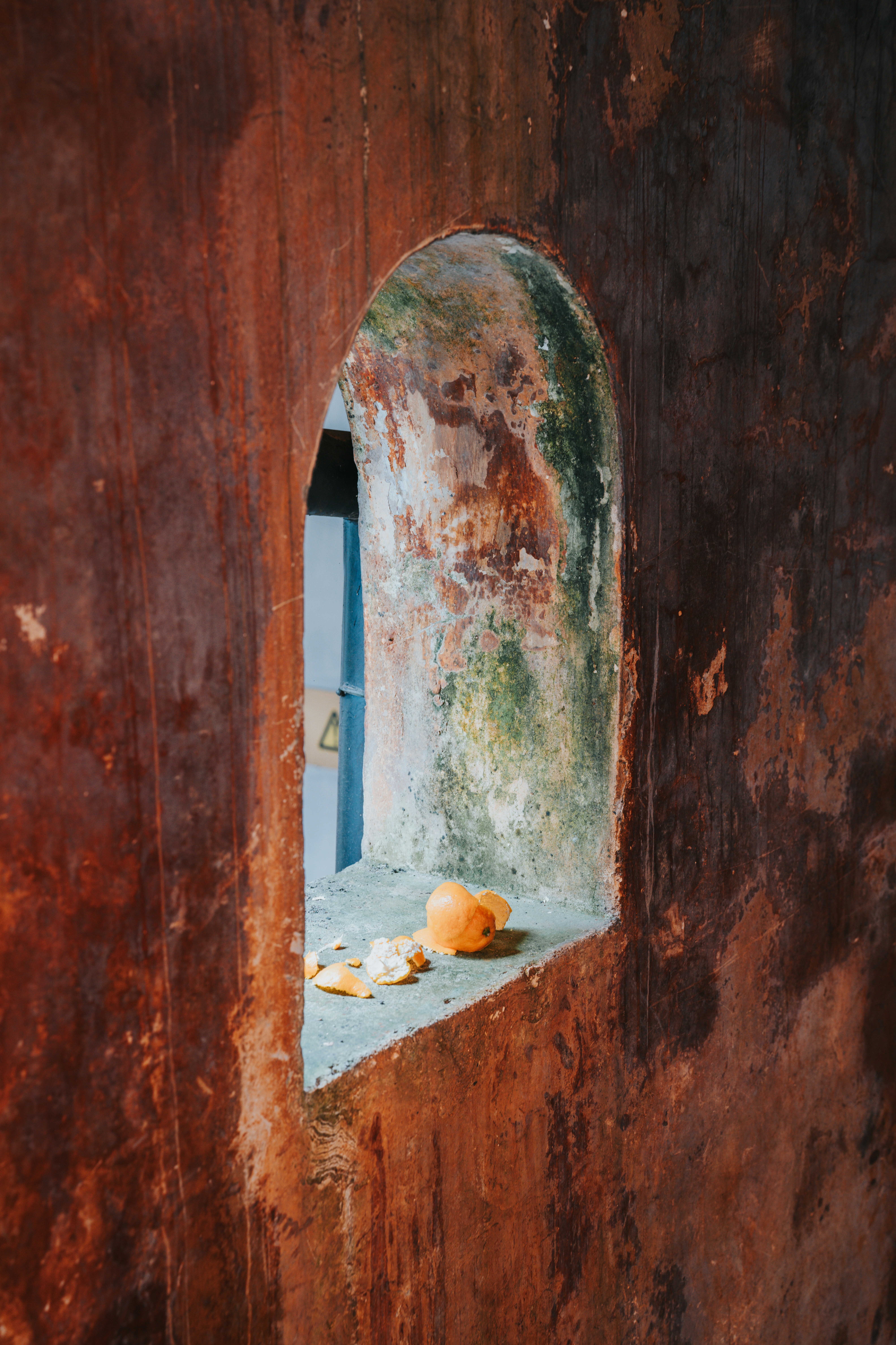 Rusty Arch, Orange Peels on a Weathered Window Sill