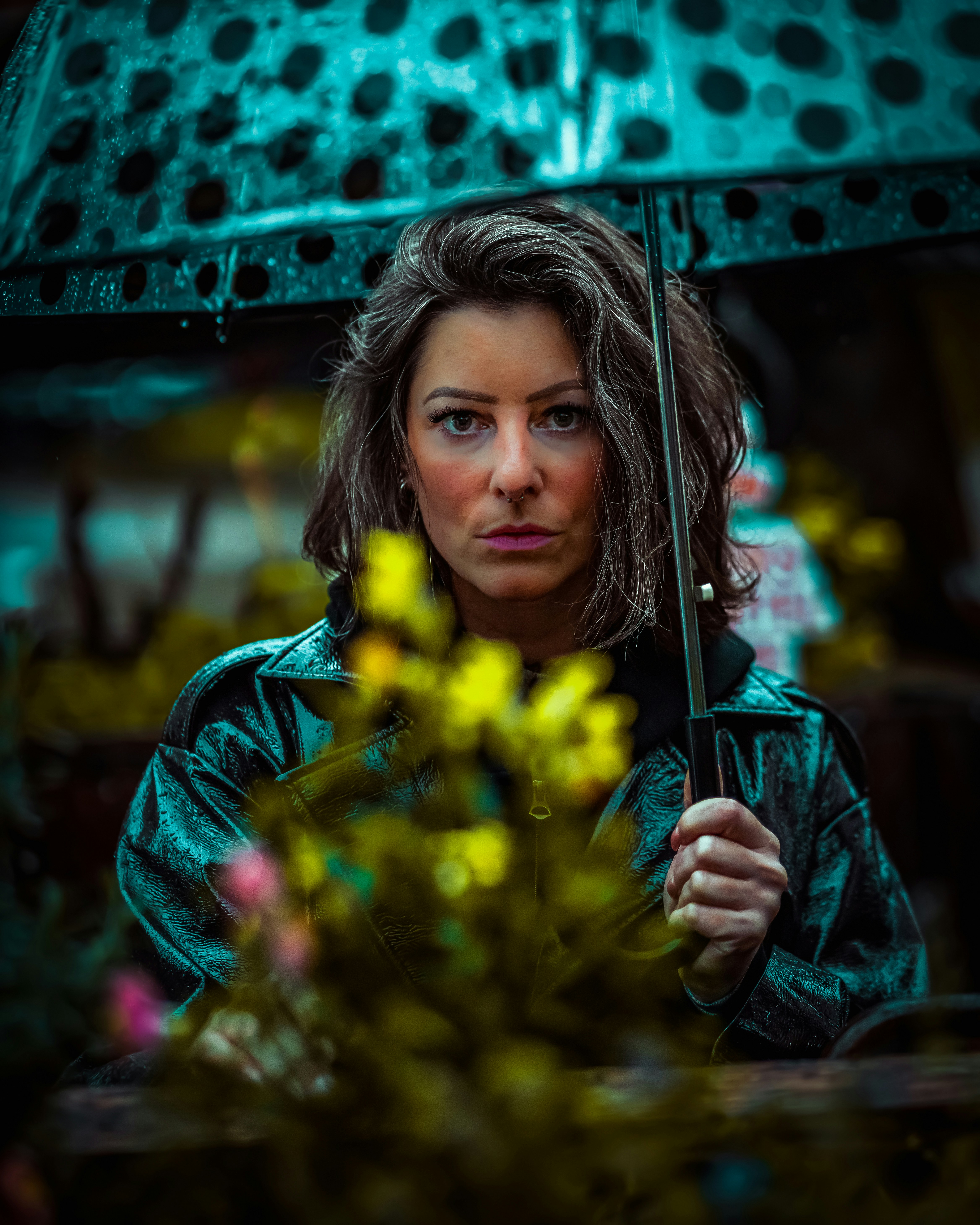 Eye Contact in the Rain: Portrait Under a Teal Umbrella