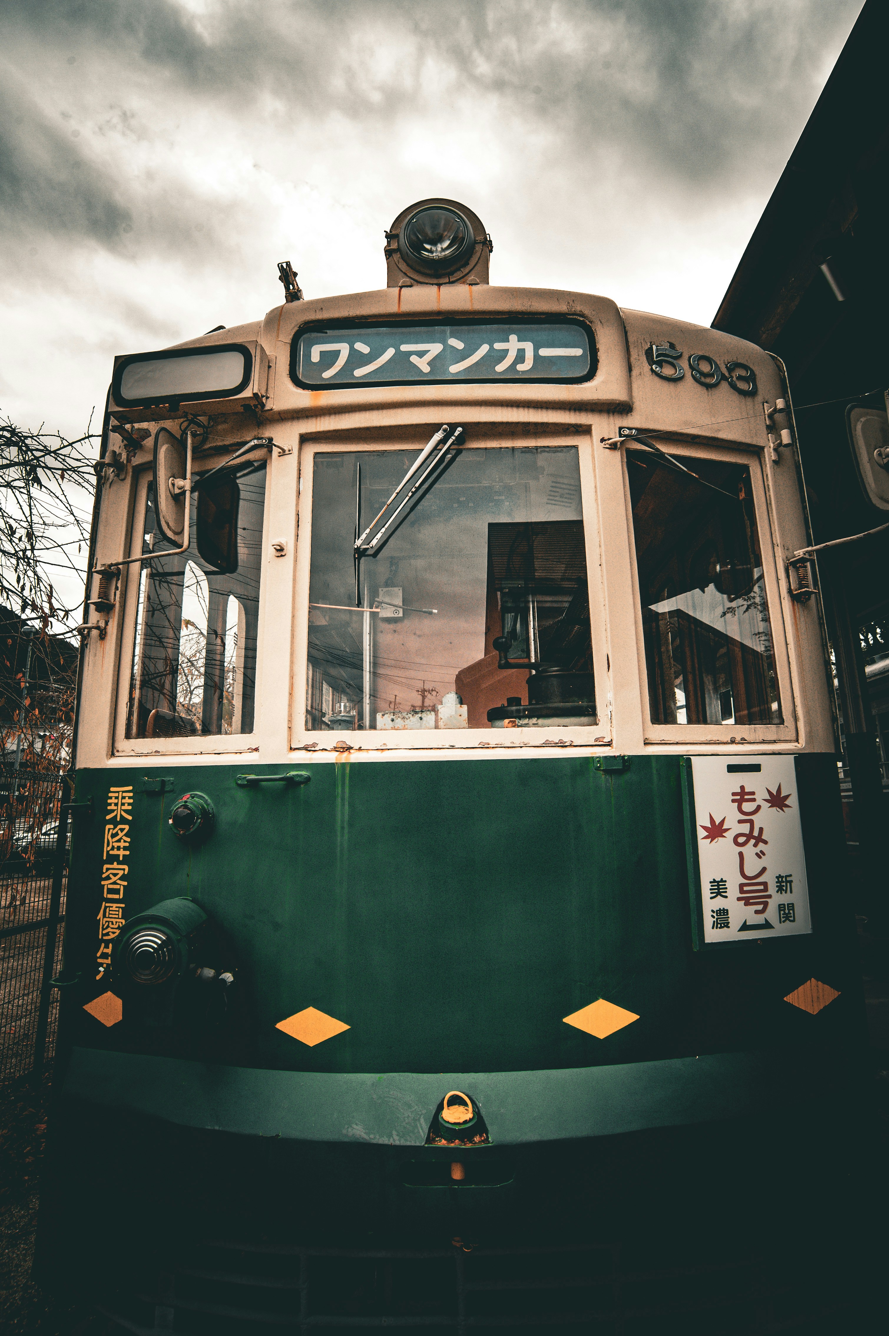 One-Man Car Tramfront: Weathered Green and Cream Under a Moody Sky