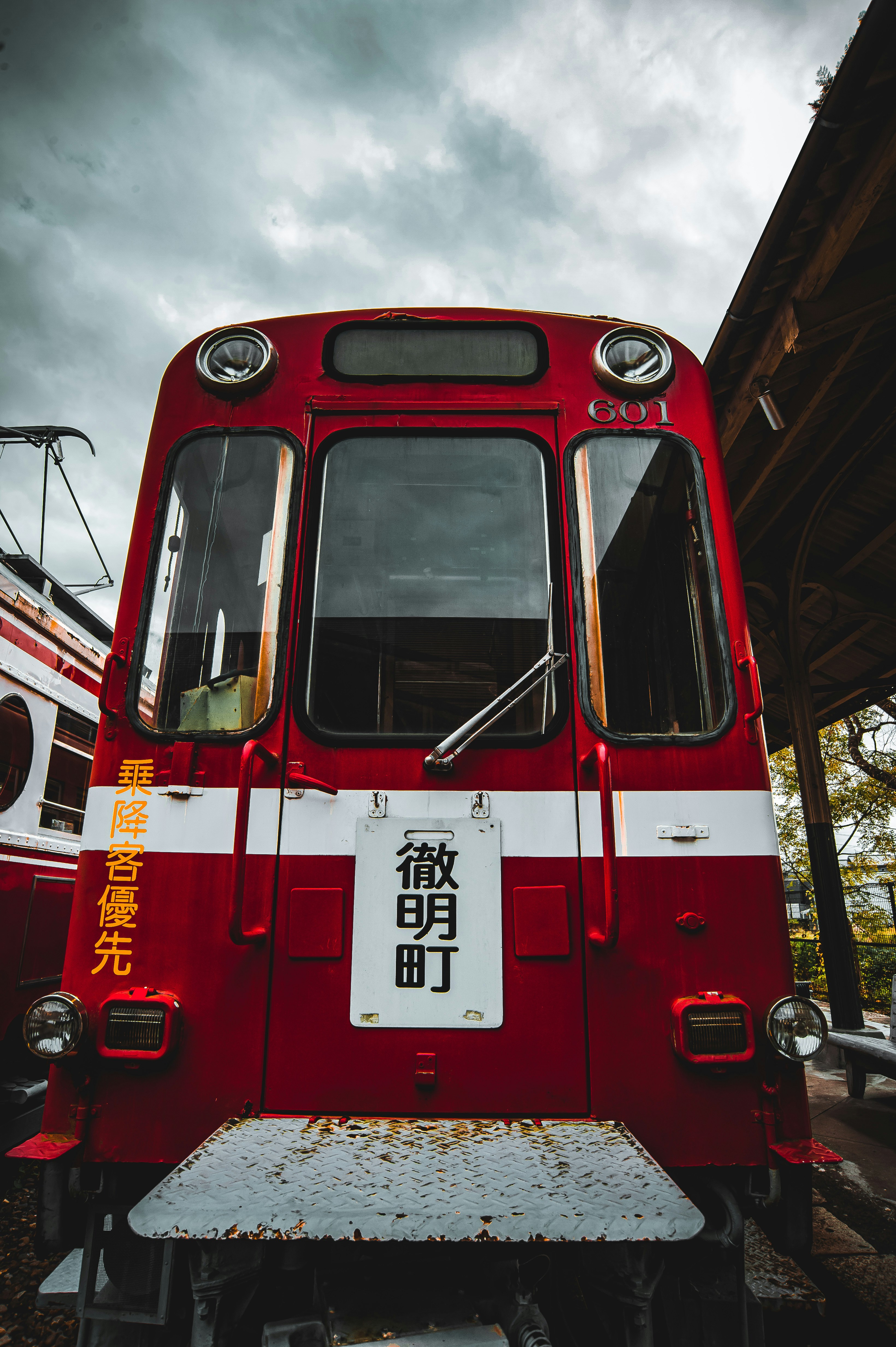 Crimson Frontage: A Vintage Railcar Framed by Platform and Sky