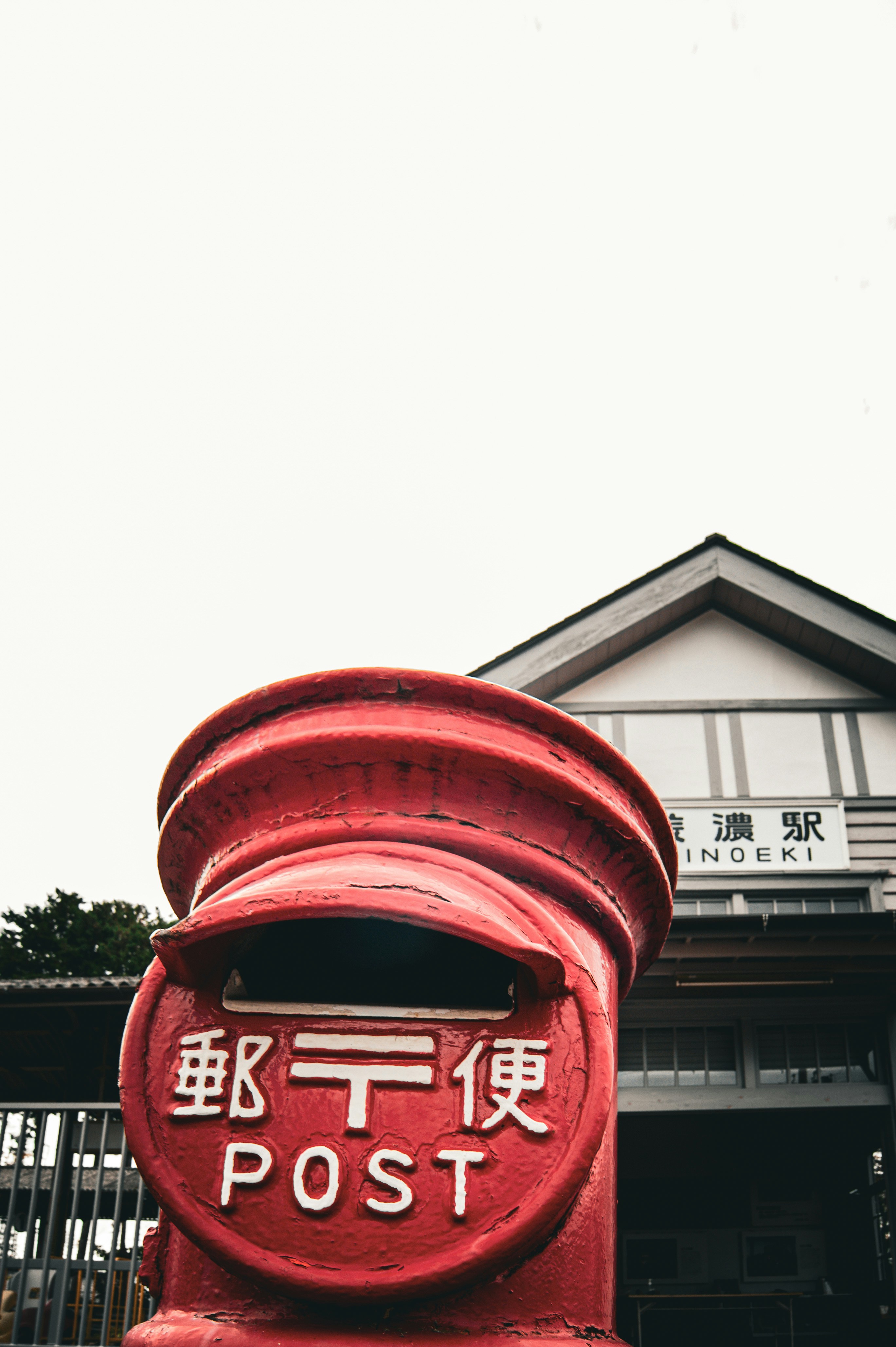 Crimson Post Box at a Quiet Japanese Station