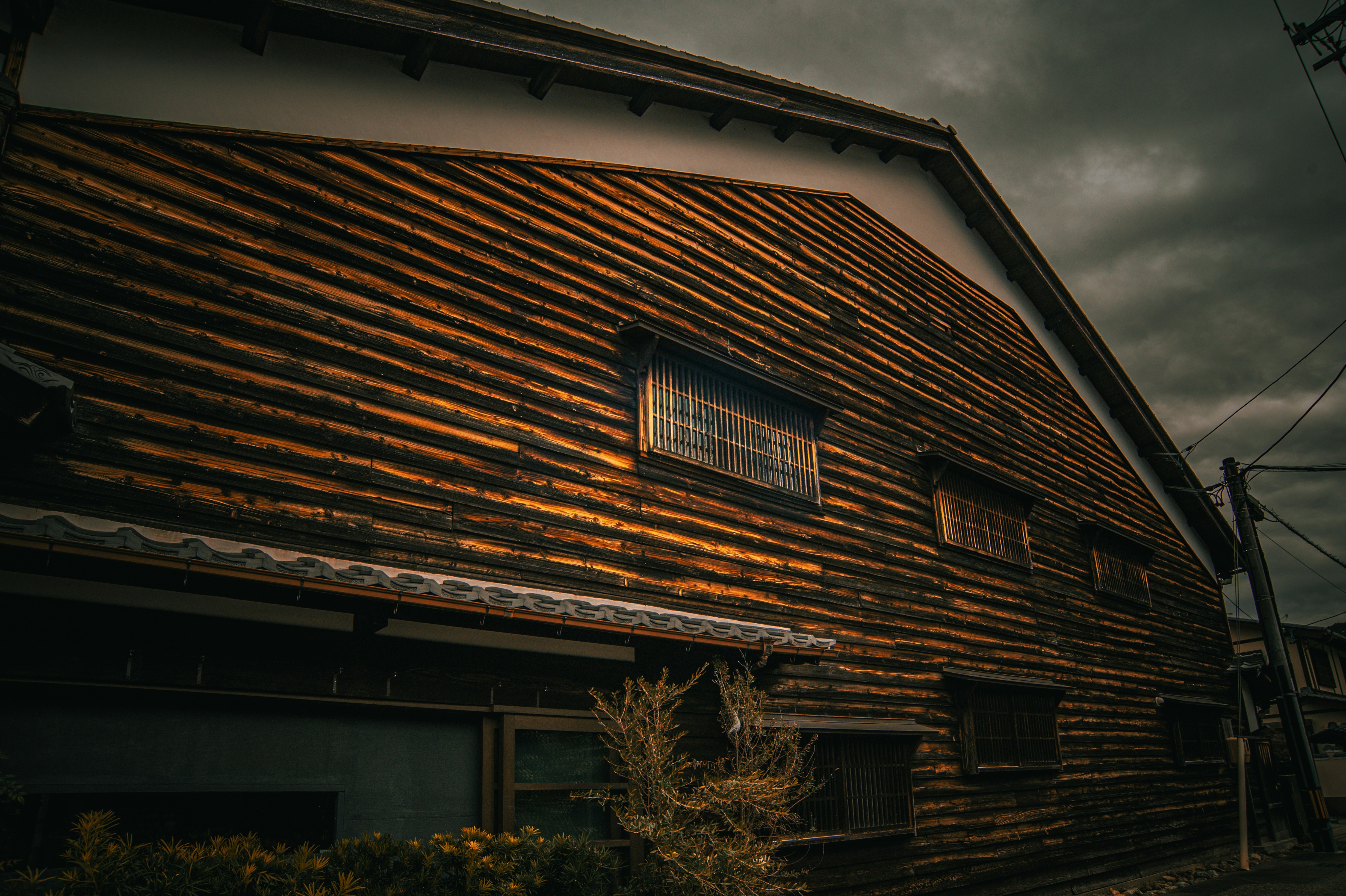 Center Window in a Weathered Warehouse Beneath a Stormy Sky