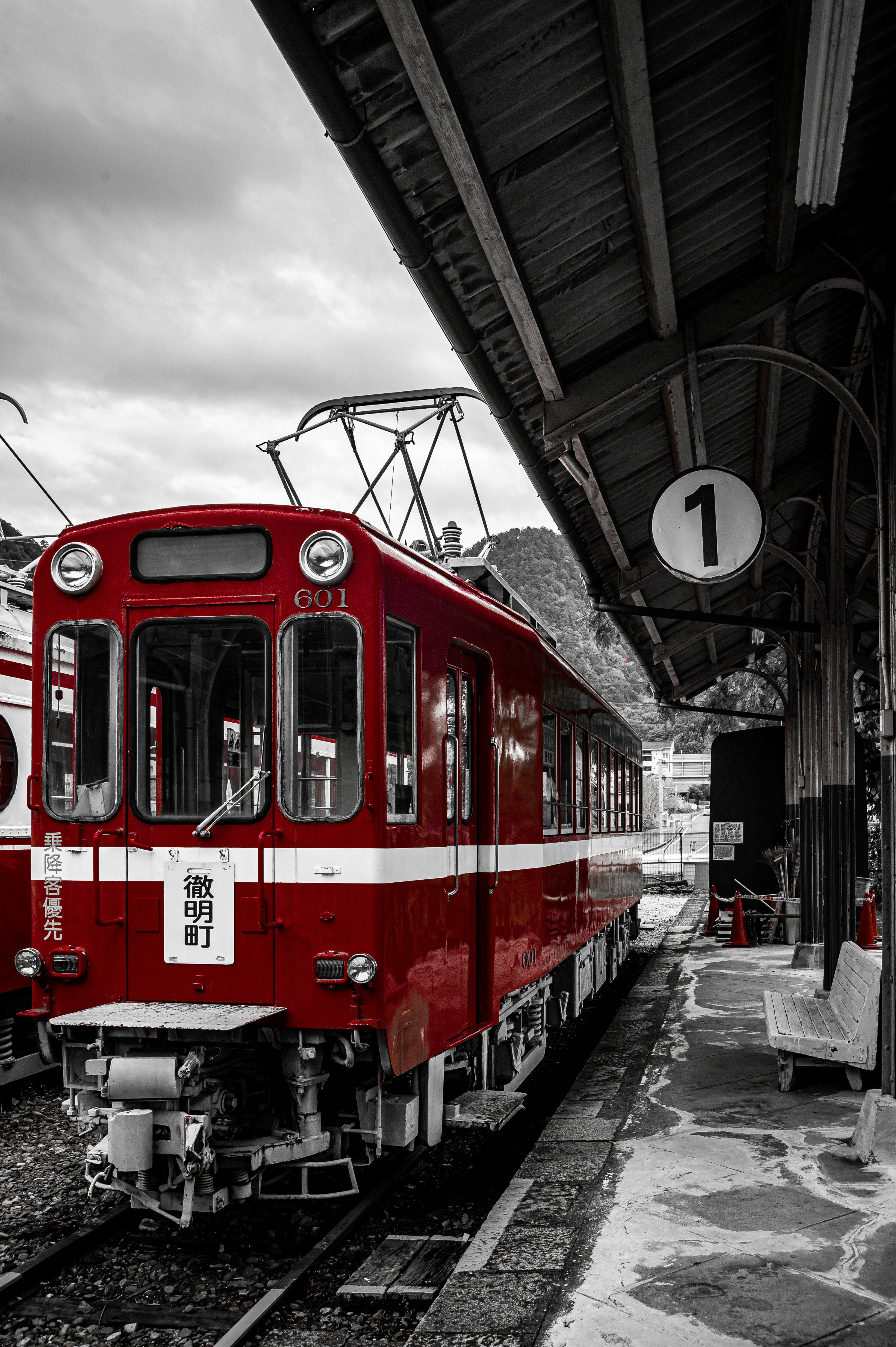 Selective Red on Rails: A Crimson Car Anchoring a Monochrome Platform