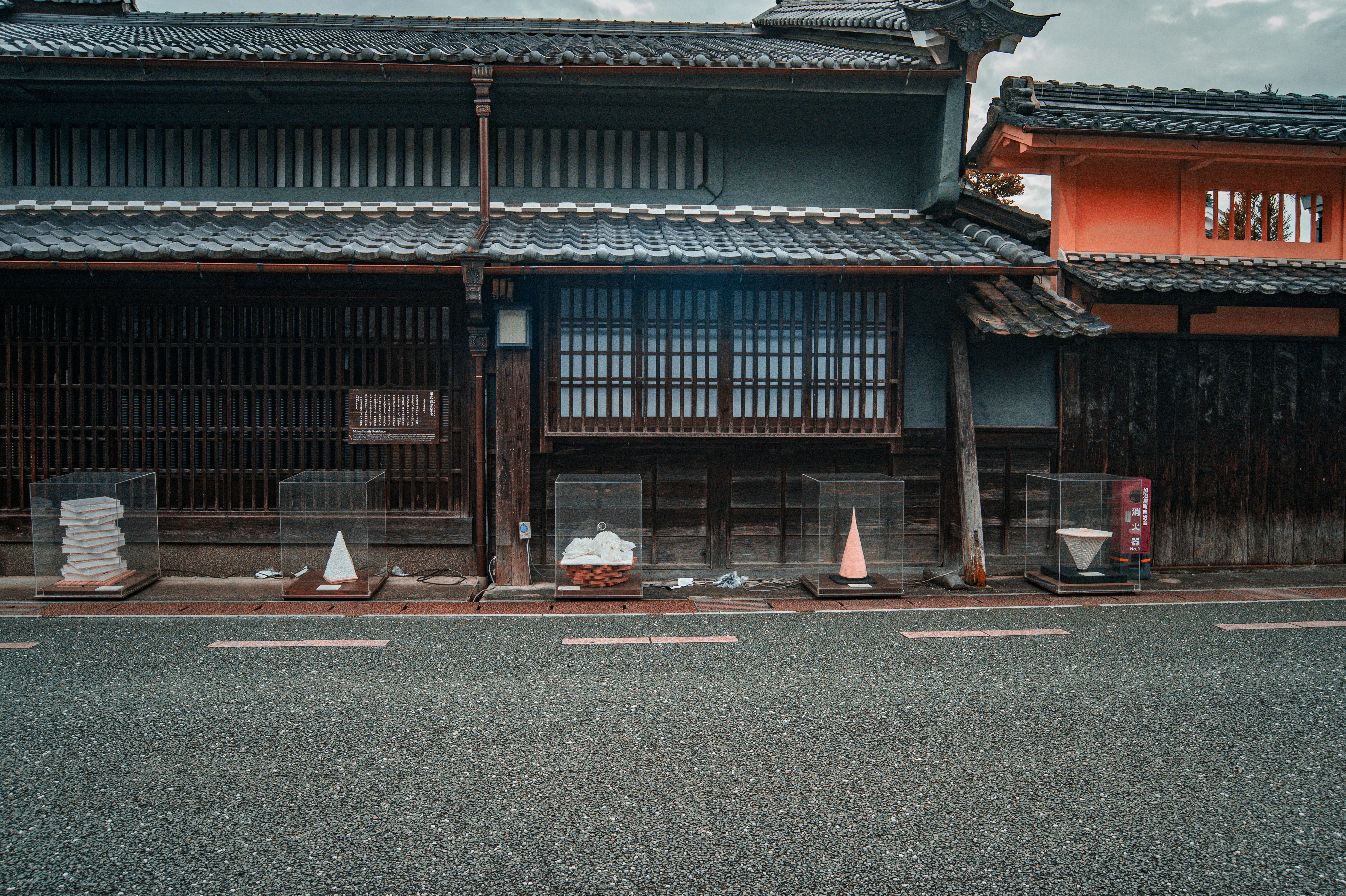 Exhibit Boxes Along a Timbered Street Facade