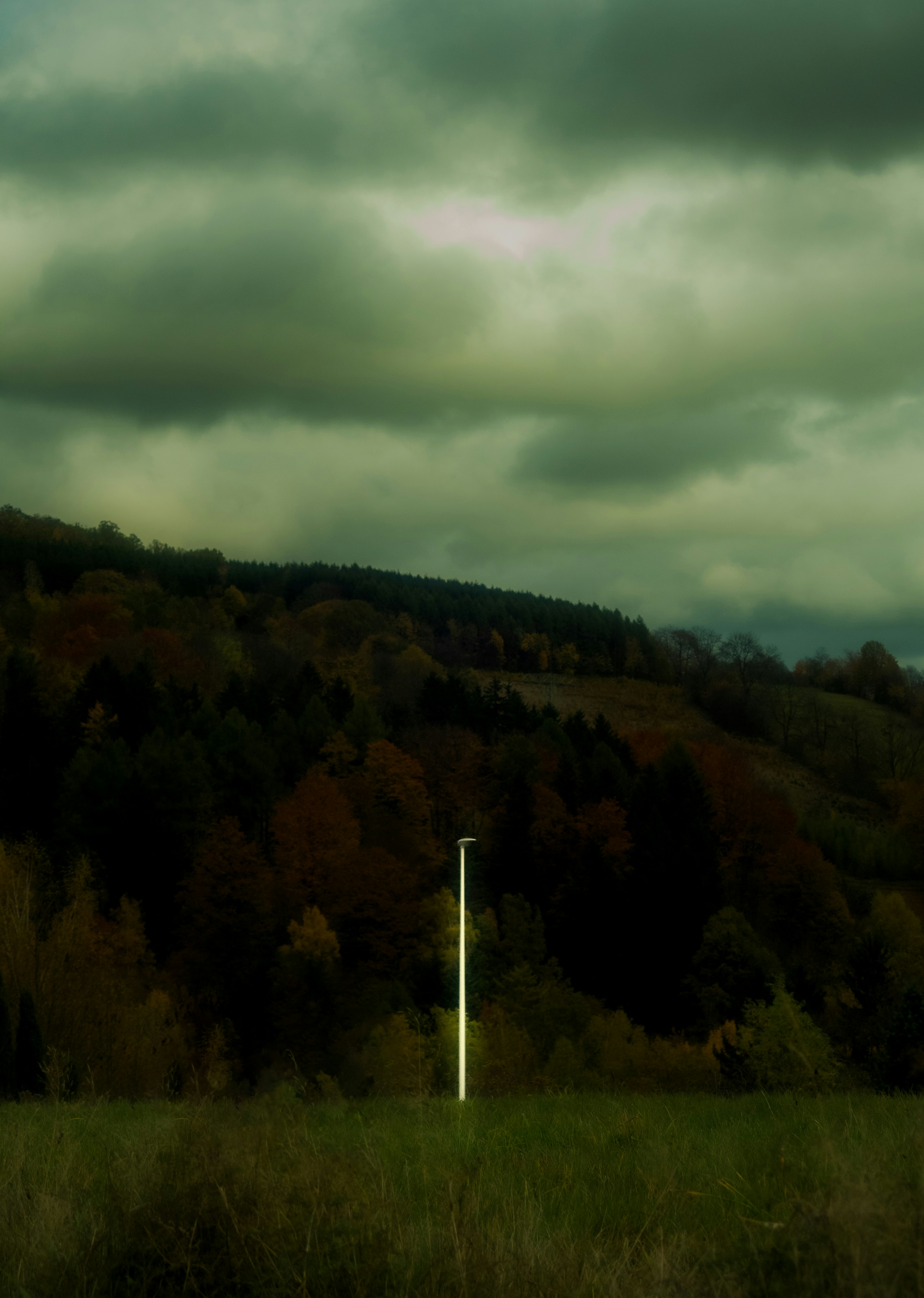 Vertical Sentinel in a Moody Autumn Valley