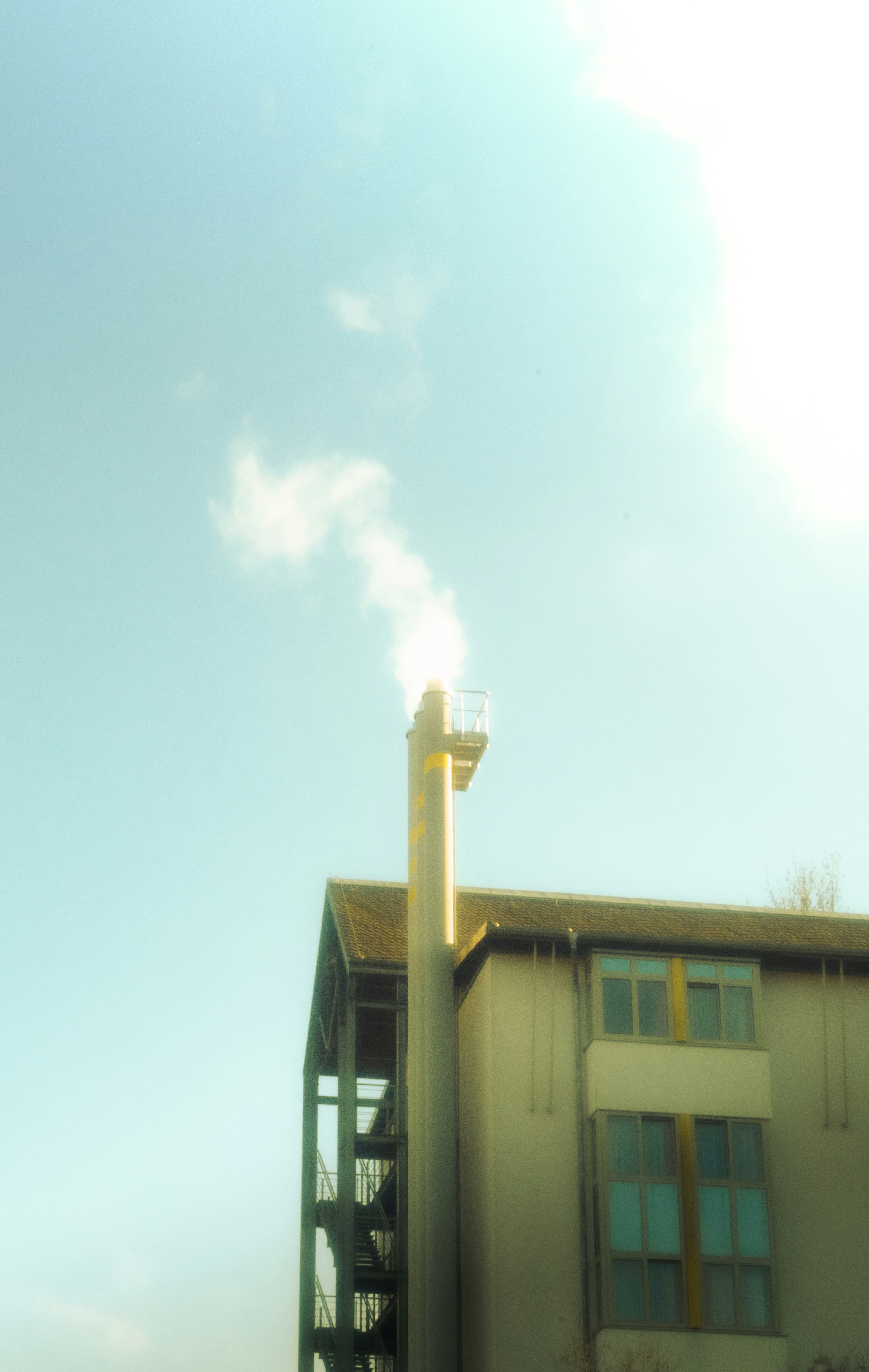 Chimney Pulse: Steam Arches Over a Modern Factory