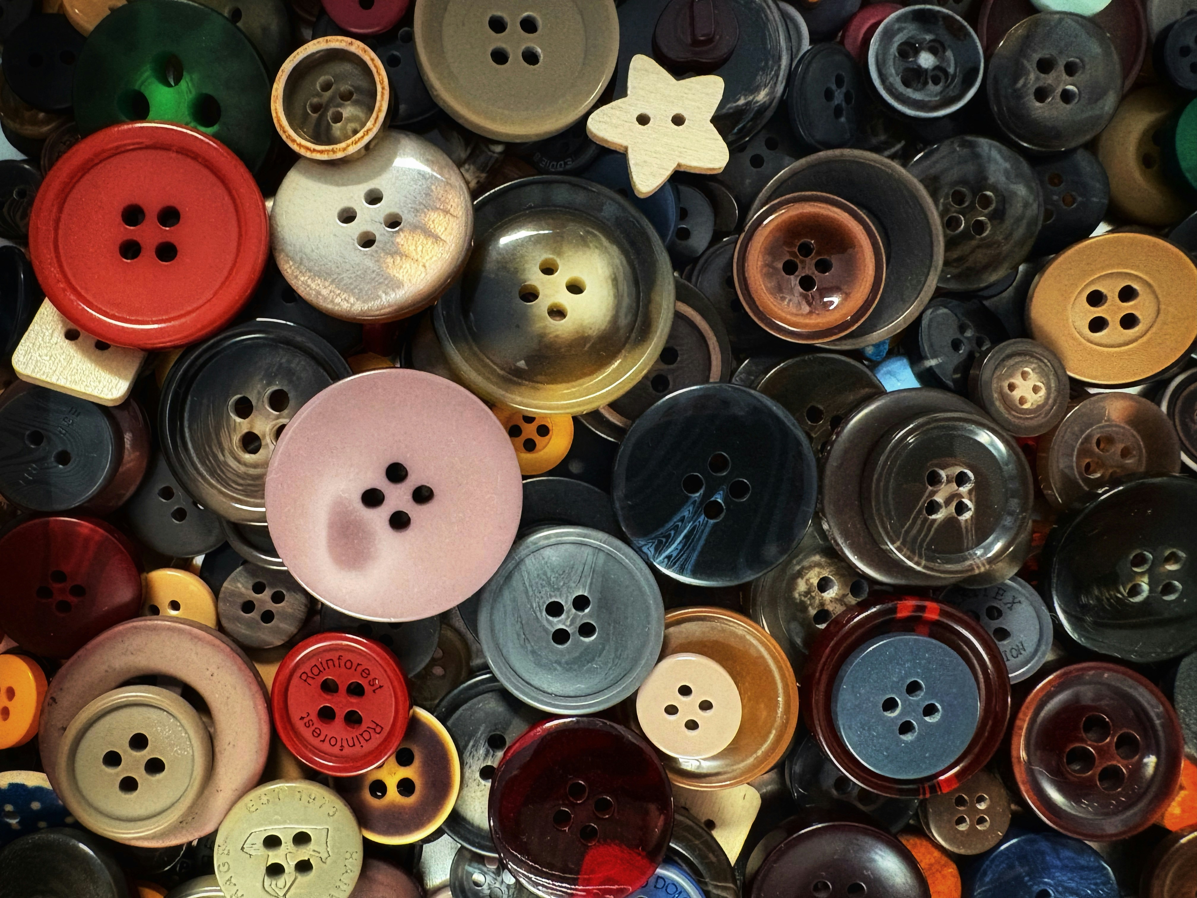 Pile of colorful buttons, top view texture background