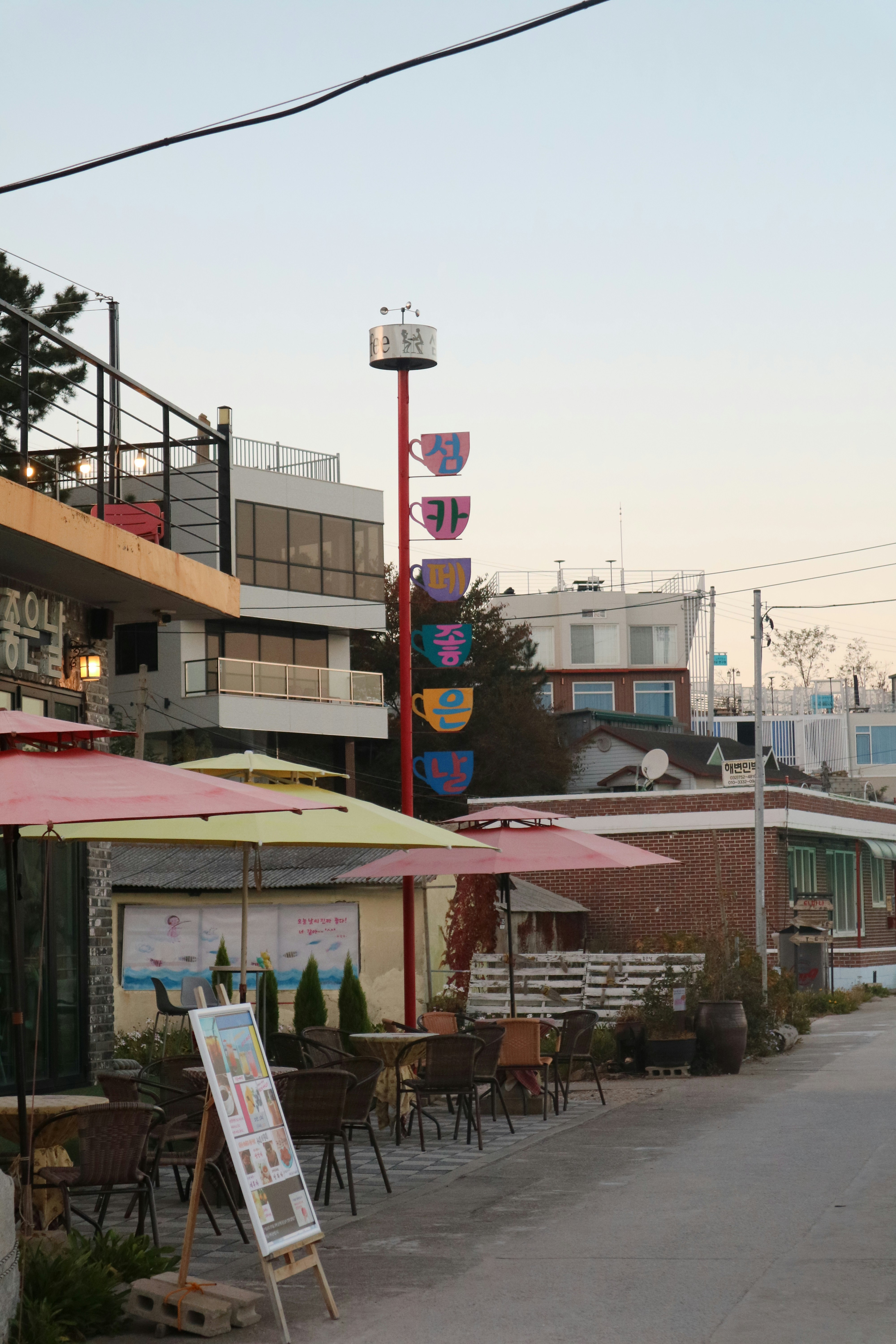 Colorful Signpost Alley Illuminates a Quiet Café Street