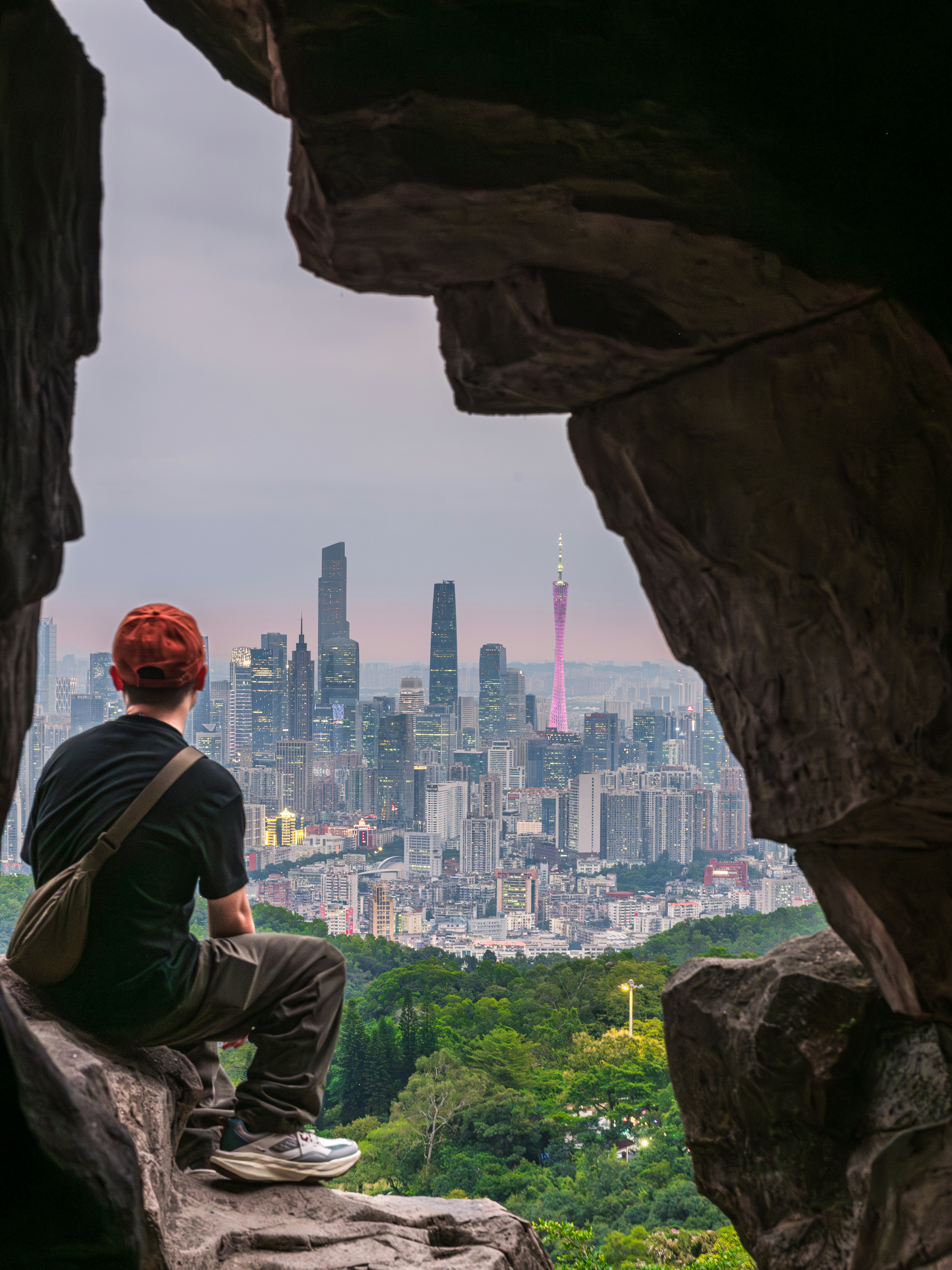 Framed at the Edge: A Traveler's Quiet View of a Neon Skyline
