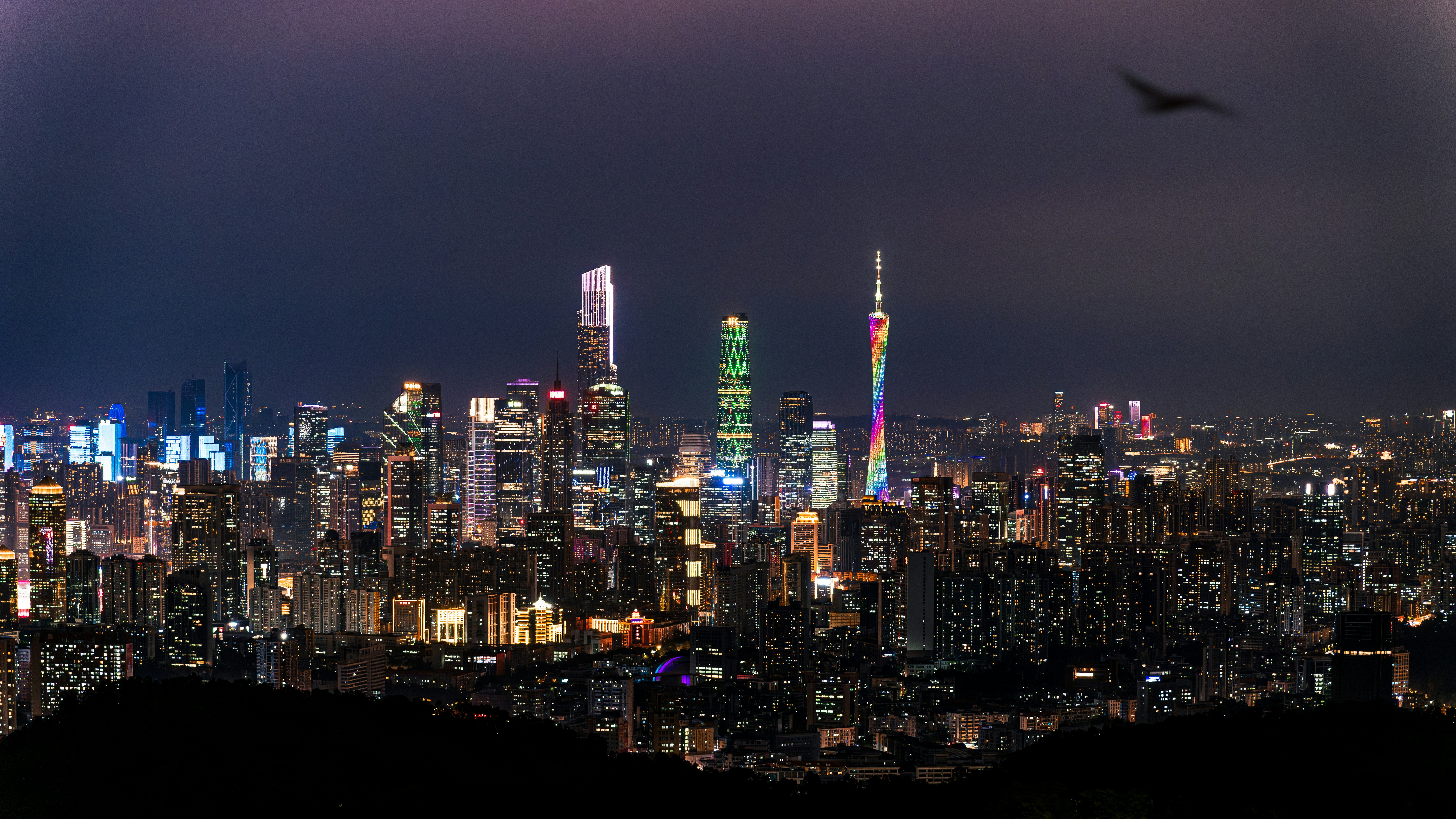 Prism-Tipped Tower Rising Above a Sea of Lights