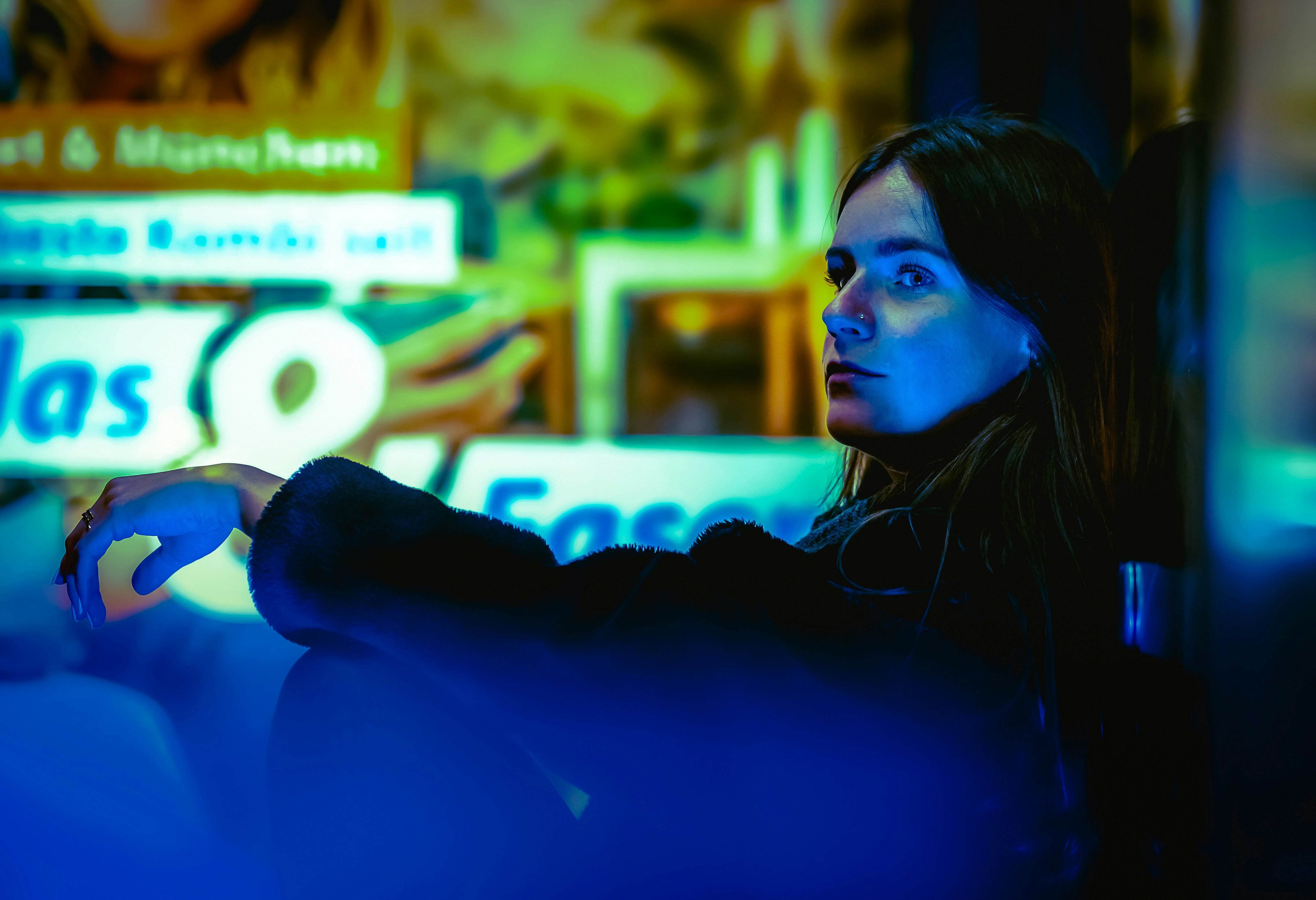 Neon Reverie: A Quiet Portrait in a Blue Arcade
