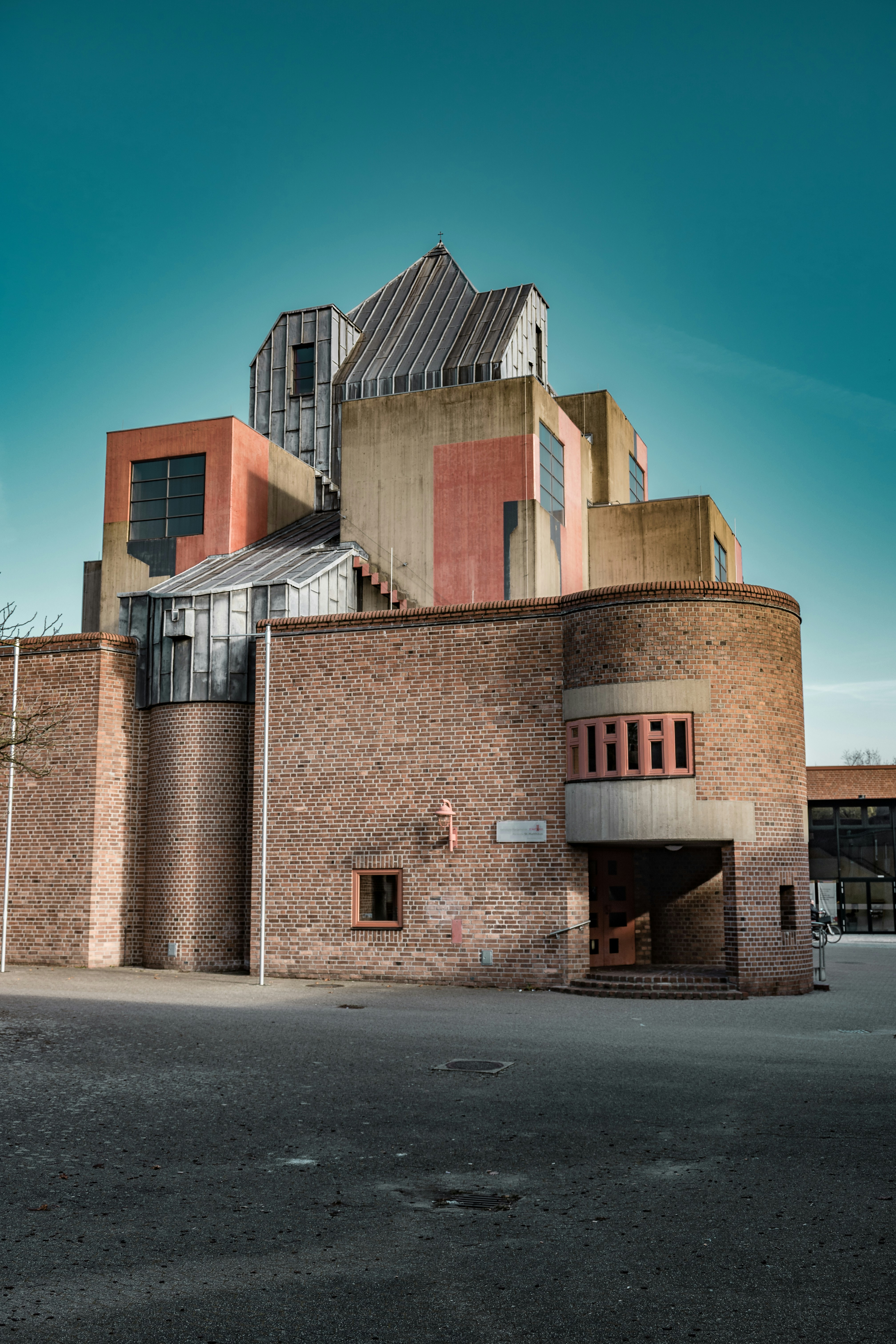 Bricks and Angles Rising Toward a Cyan Sky