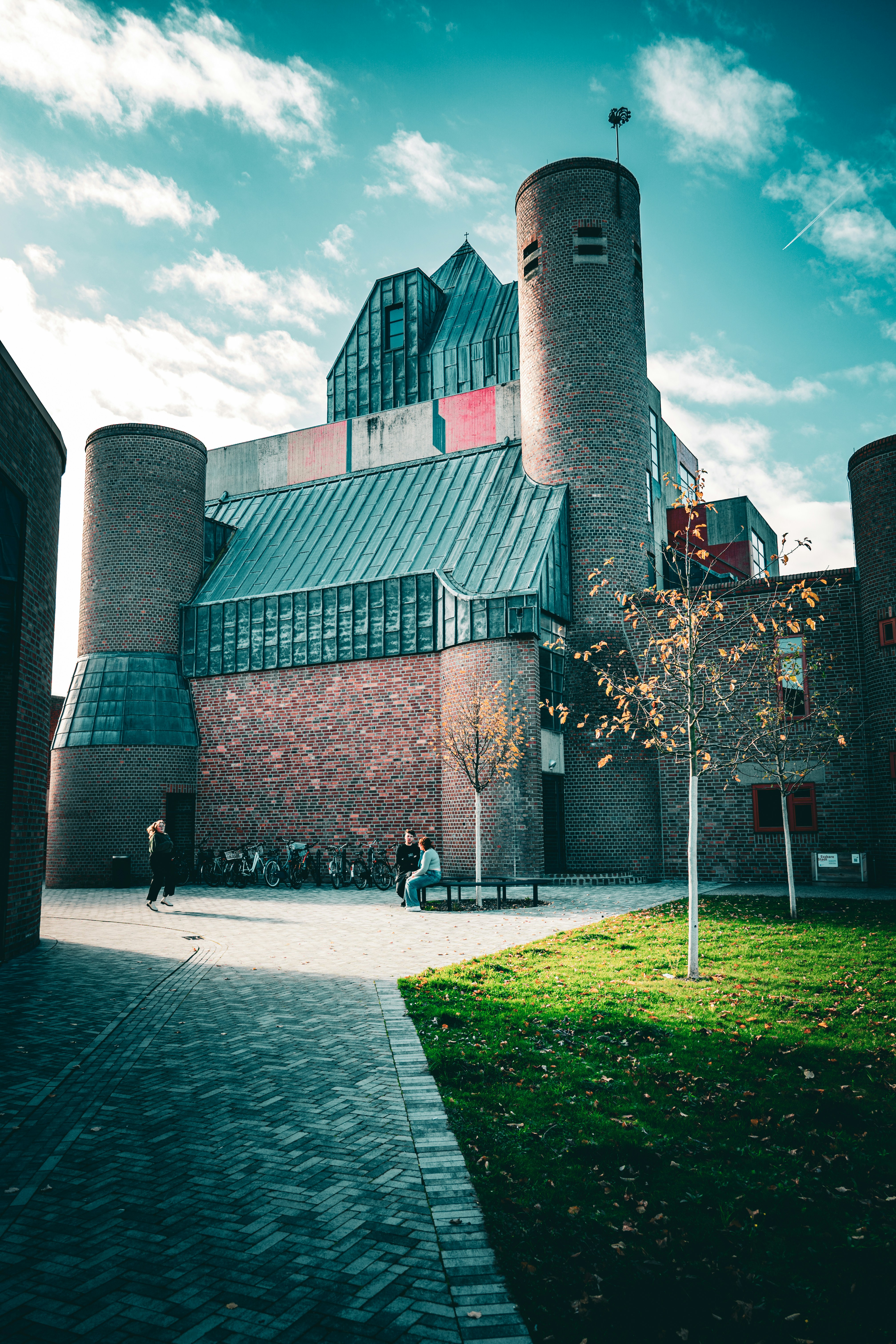 Teal Sky Over Brick Cylinders: A Quiet Campus Monument