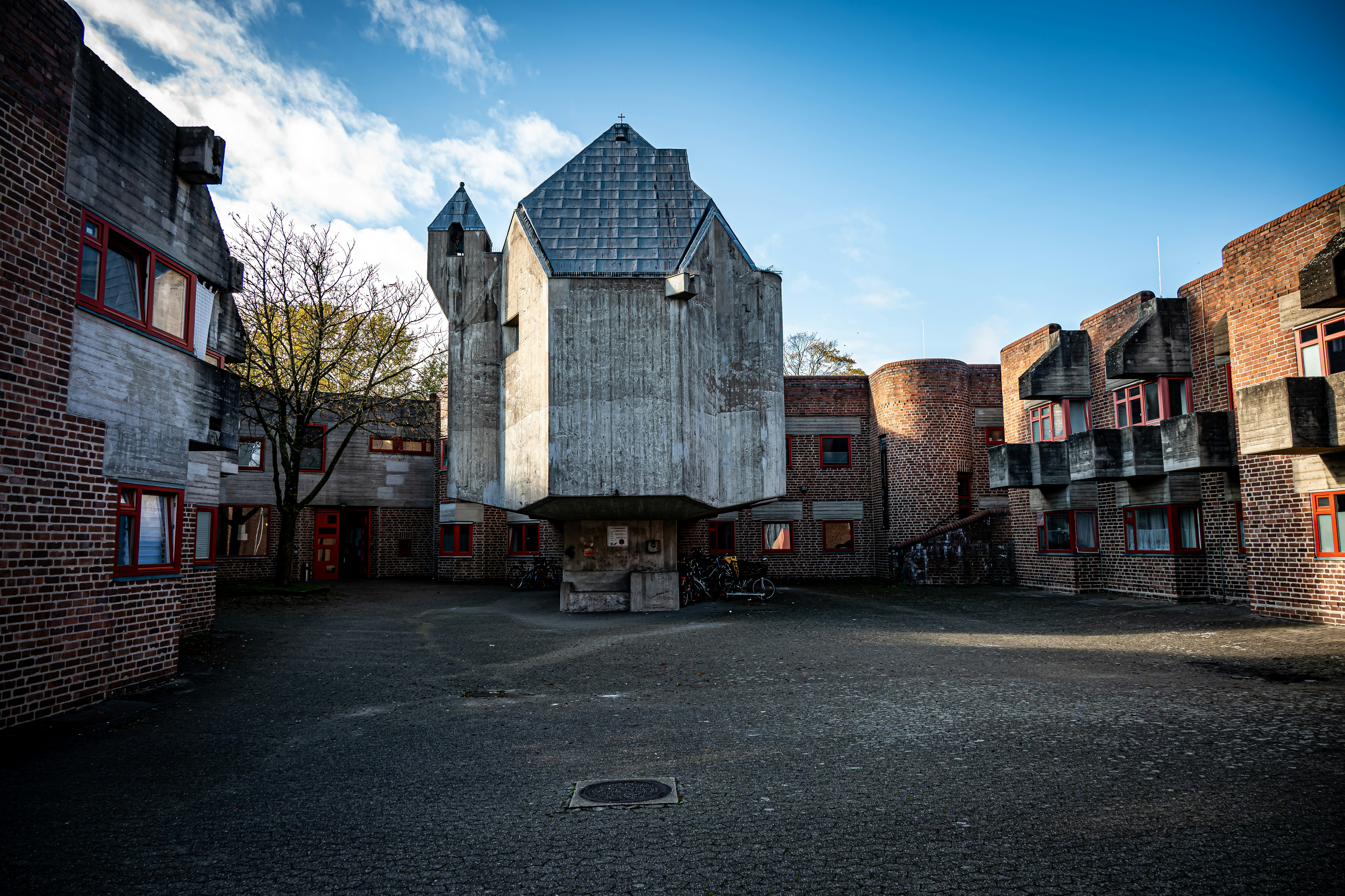 Monolithic Centerpiece Rising Over a Quiet Brick Courtyard