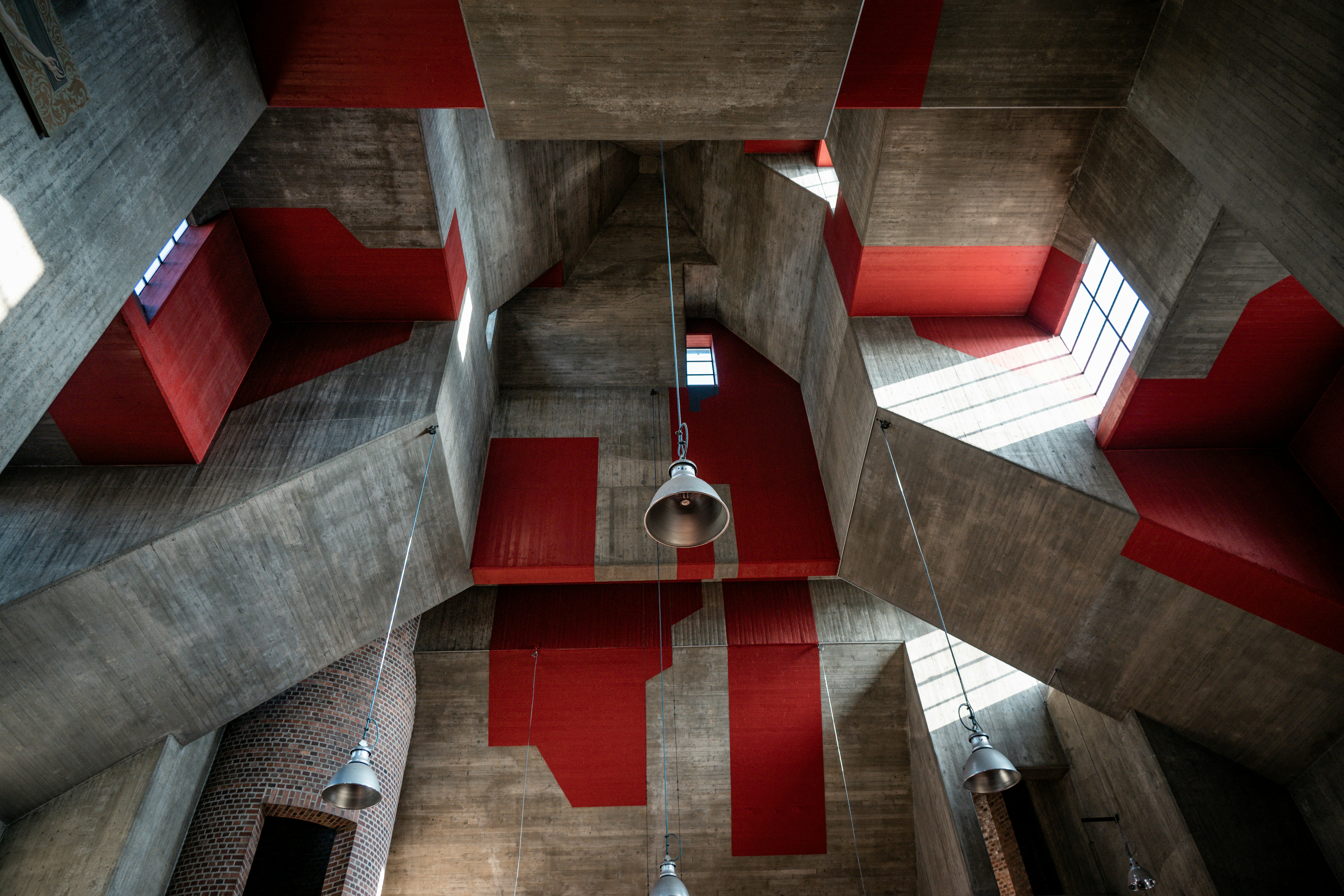 Crimson Geometry: Red Blocks and Hanging Light in a Concrete Cathedral