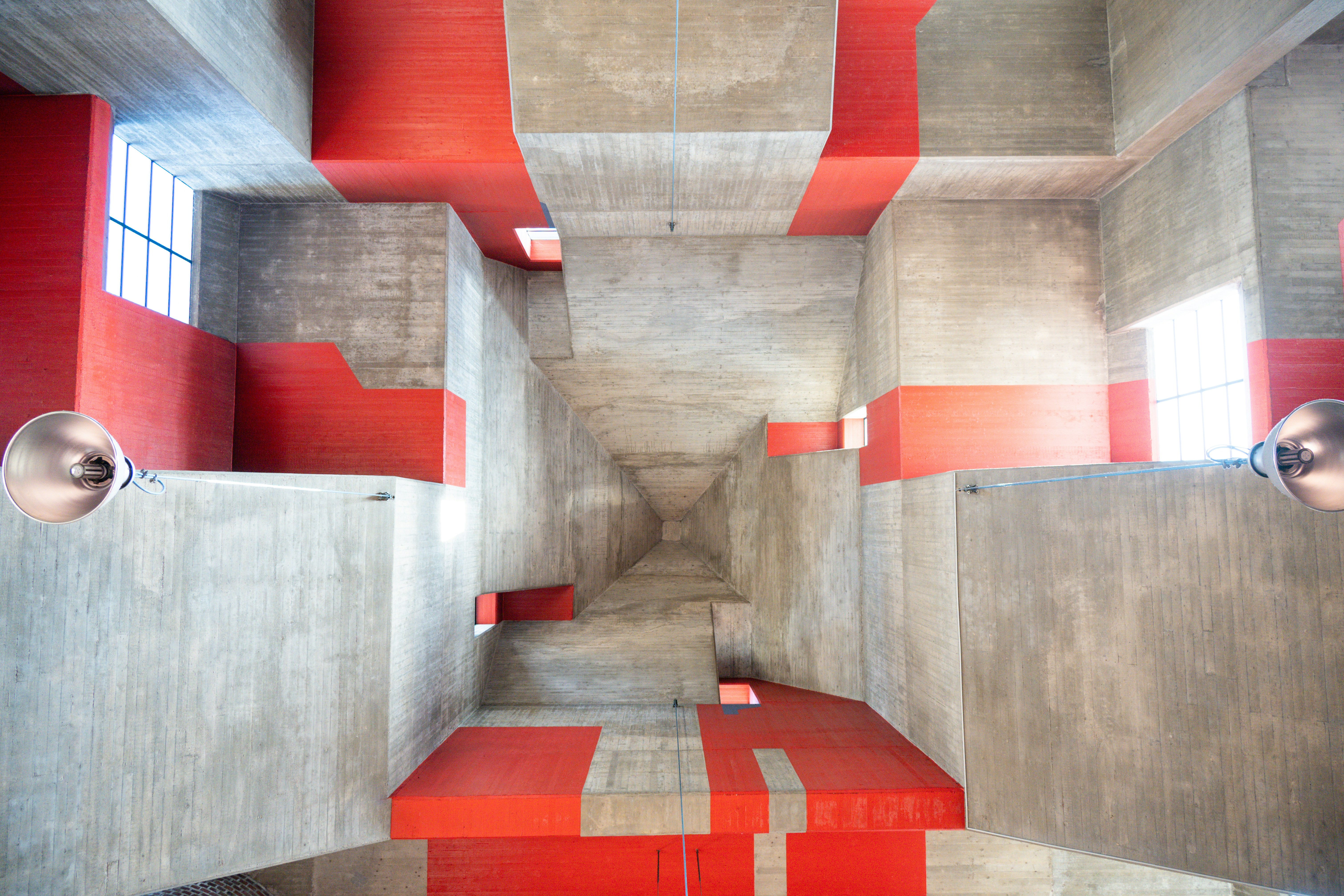 Red Geometry in a Concrete Canyon: A Vanishing-Point Architectural Portrait