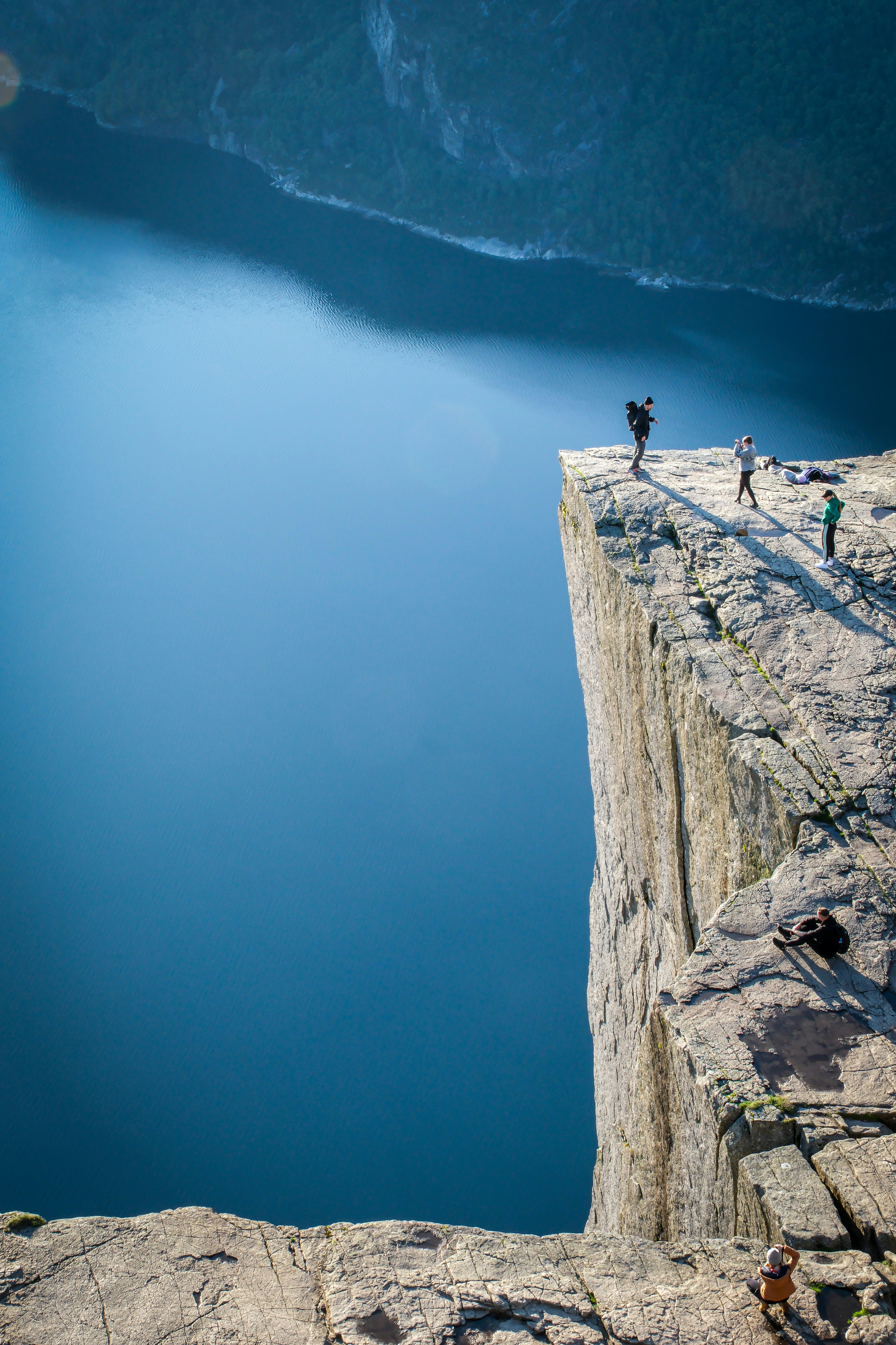 Brink of the Blue: Figures on a Narrow Cliff Over a Vast Abyss