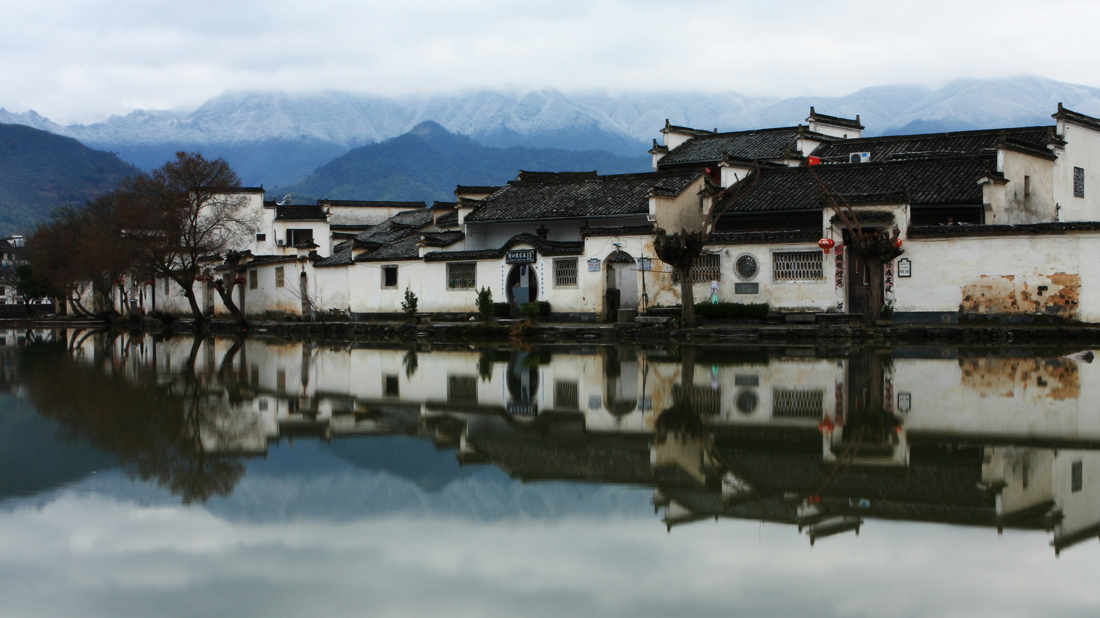 Traditional village buildings reflected in tranquil water photo – Free ...