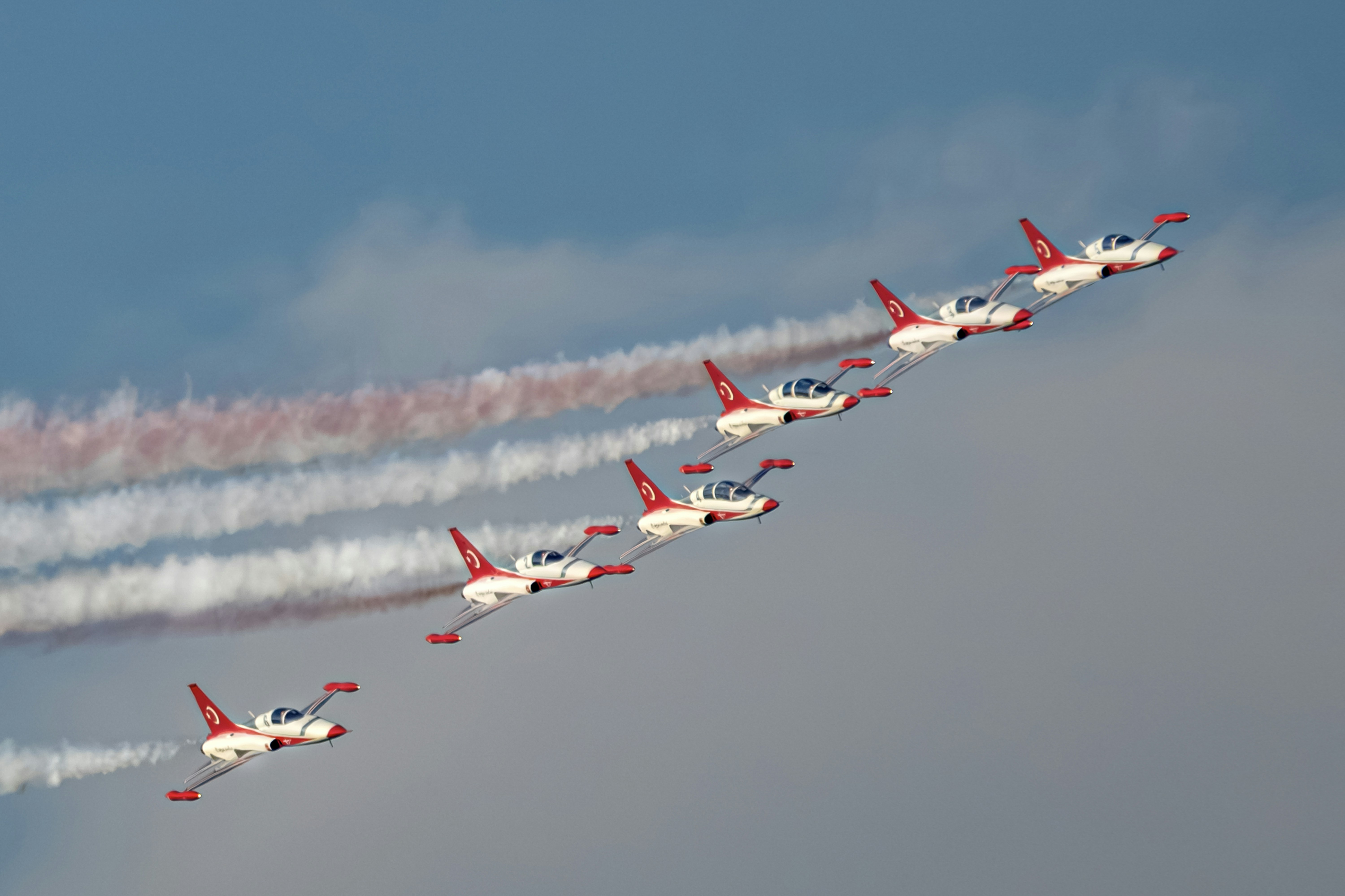 Crimson Arrow: A Tight Red-Jet Formation Traces Colored Smoke Across the Sky