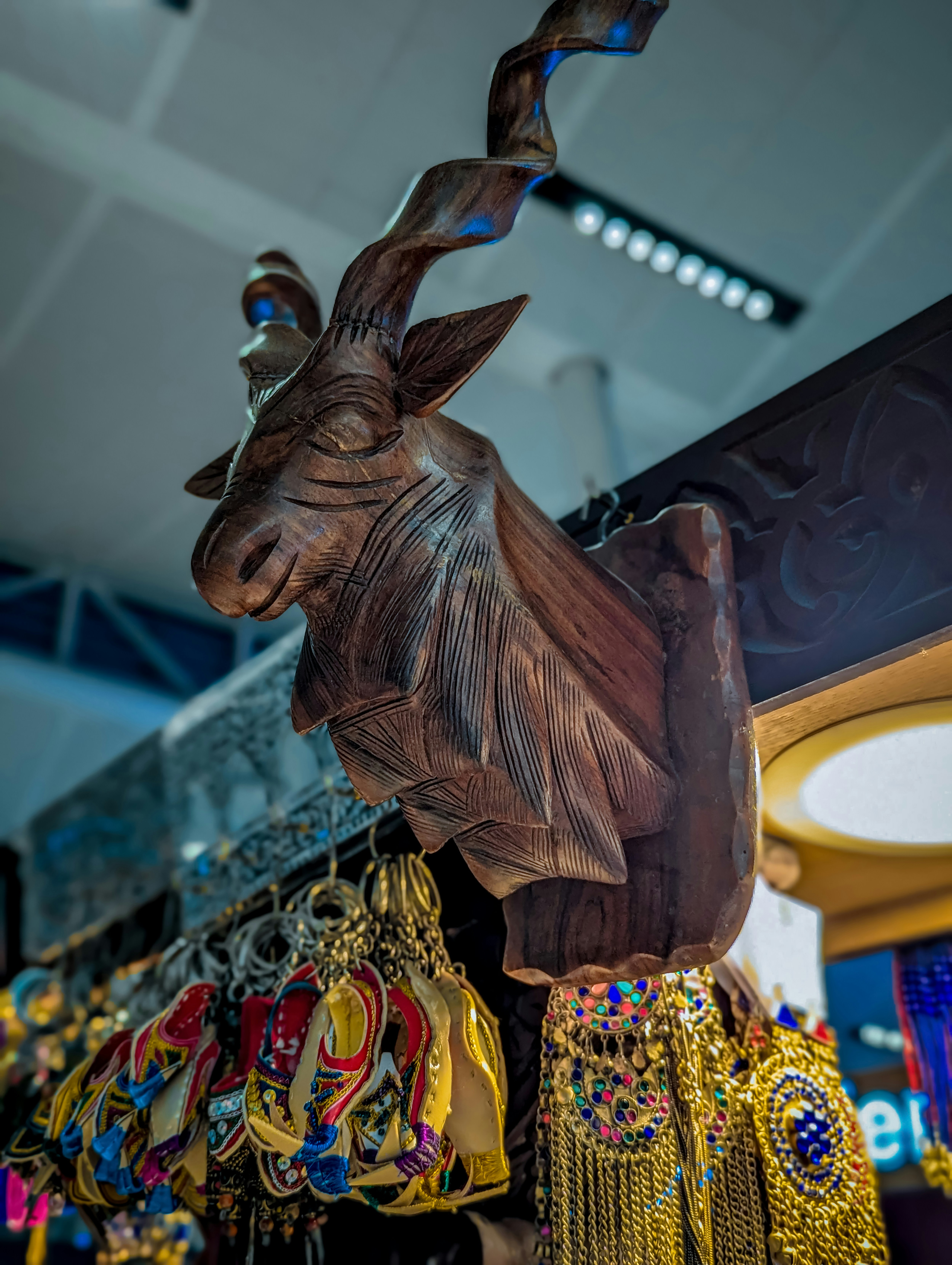 Antlered Sentinel: A Hand-Carved Stag Looms Over Sparkling Trinkets