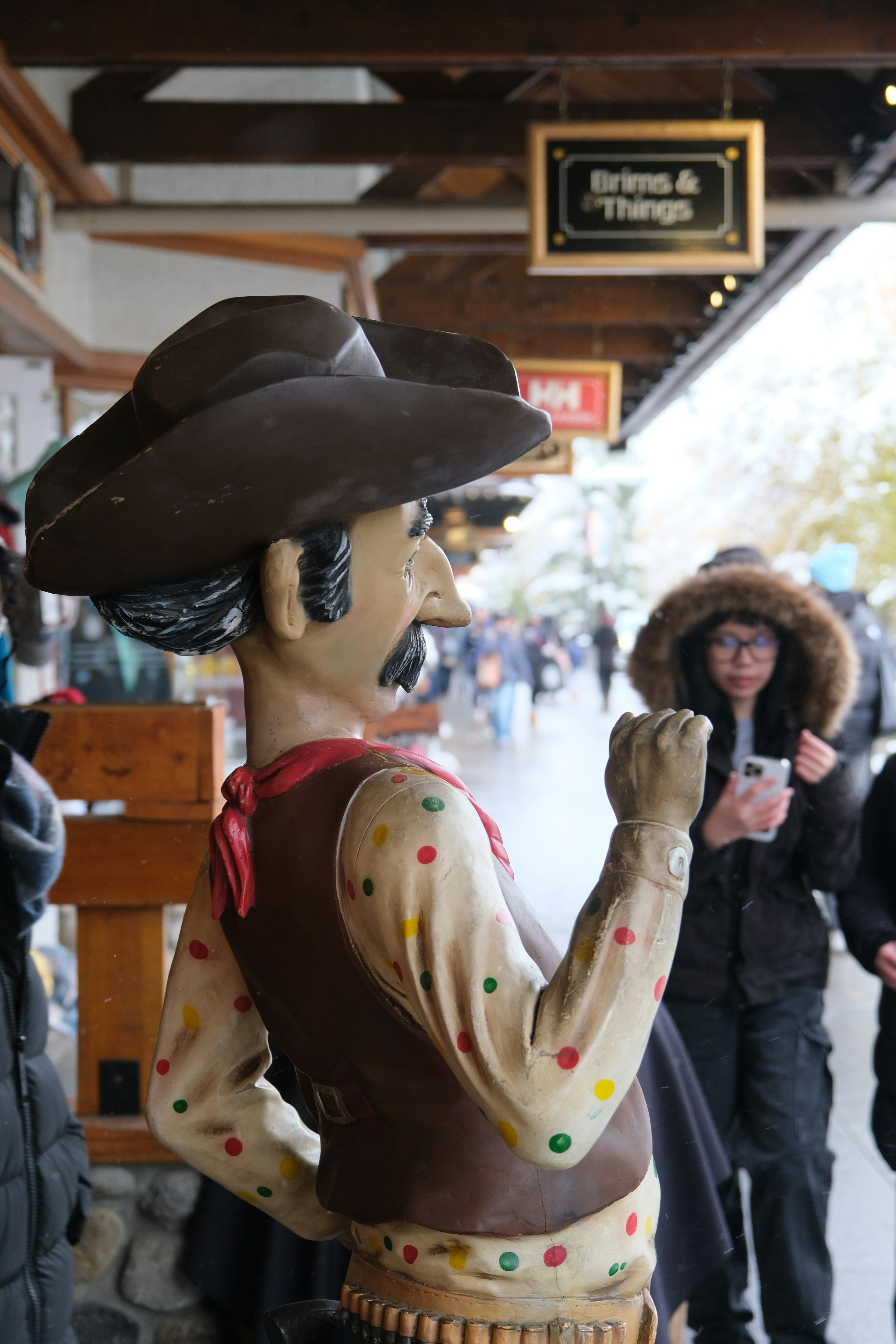 Polished Cowboy in a Market Arcade: A Quiet Icon Amid Busy Footfall
